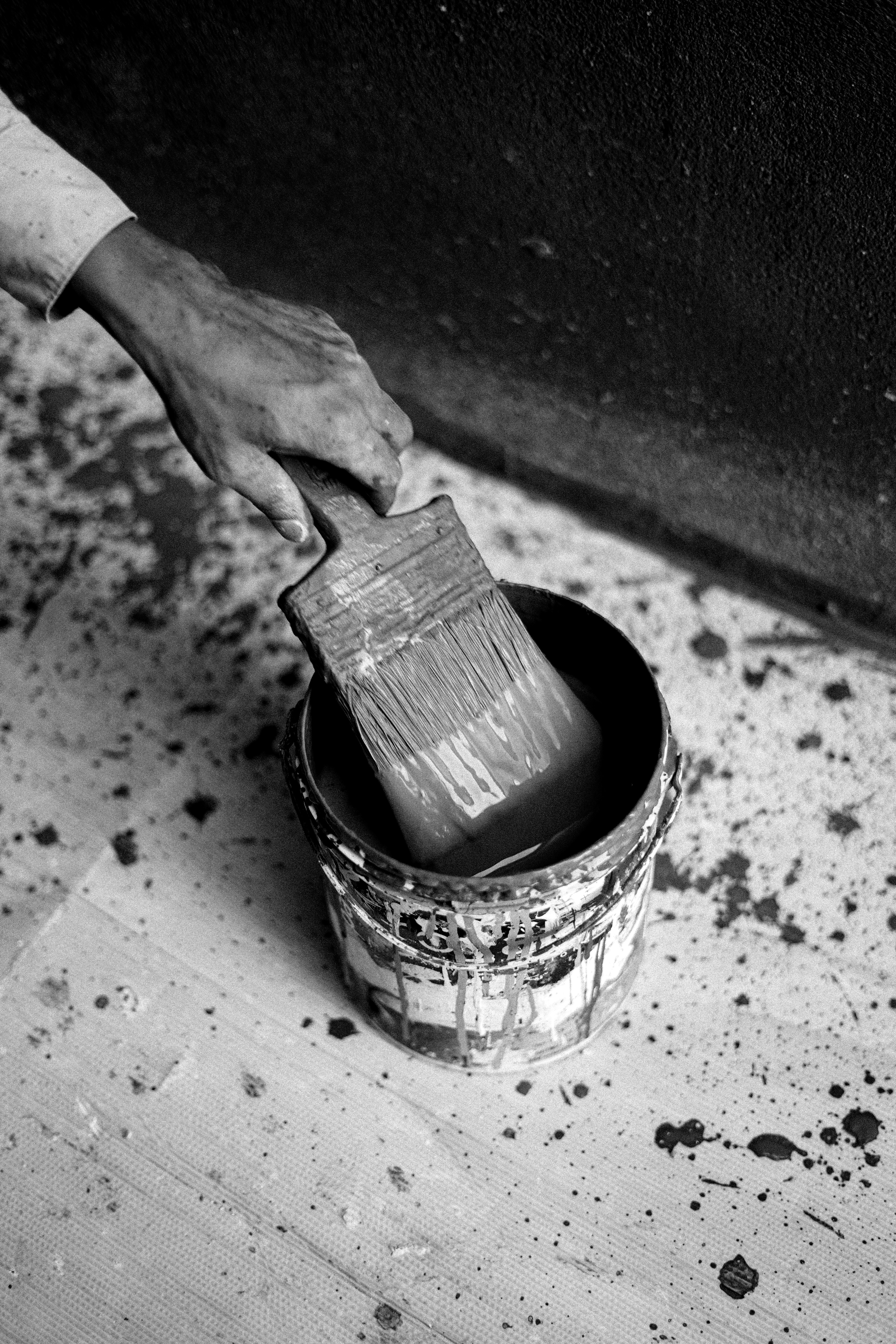 Monochrome Gesture: A Brush Dips Into Wet Paint