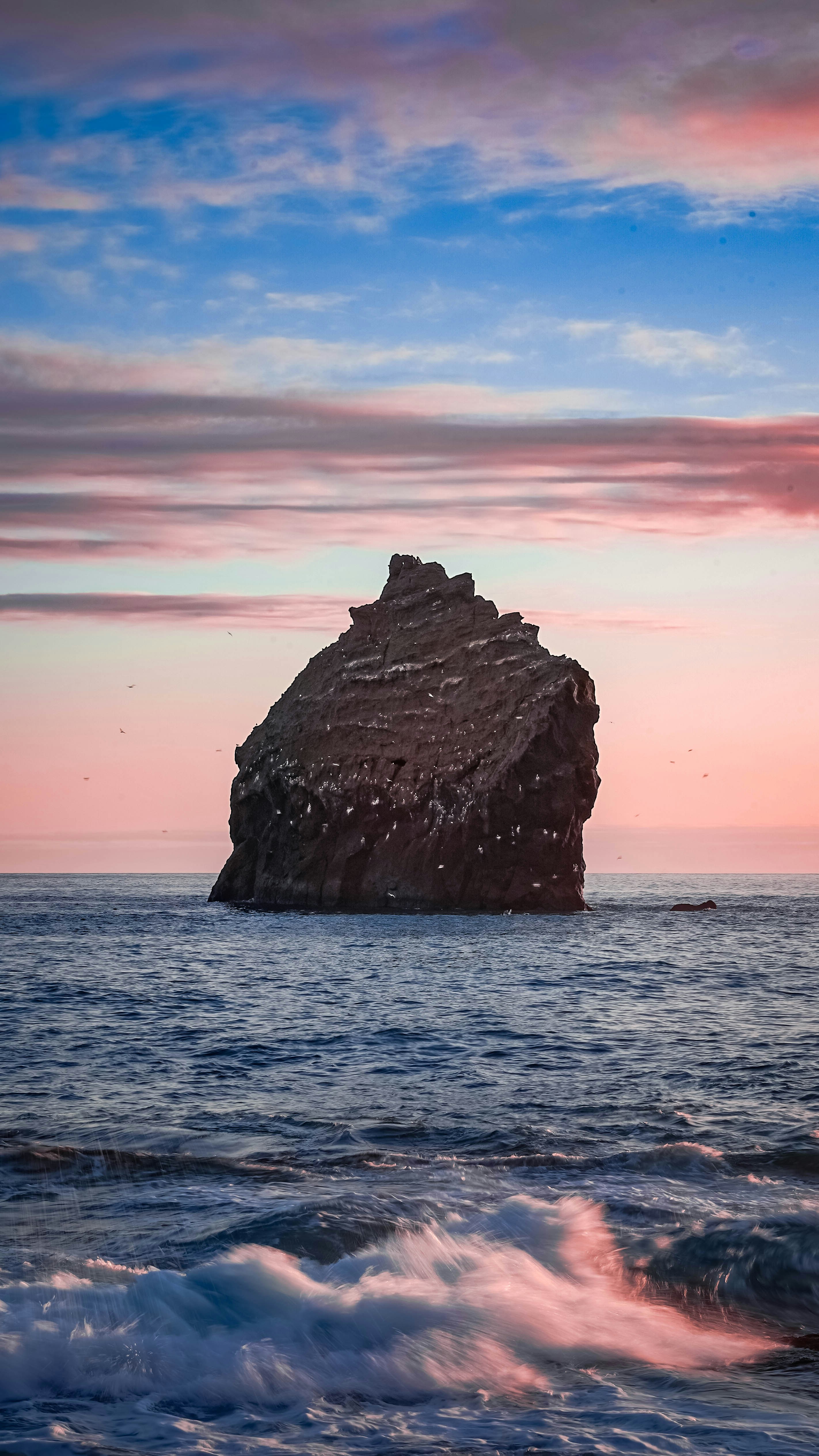 Sea Stack at Dusk: A solitary basalt sentinel amid pastel tides