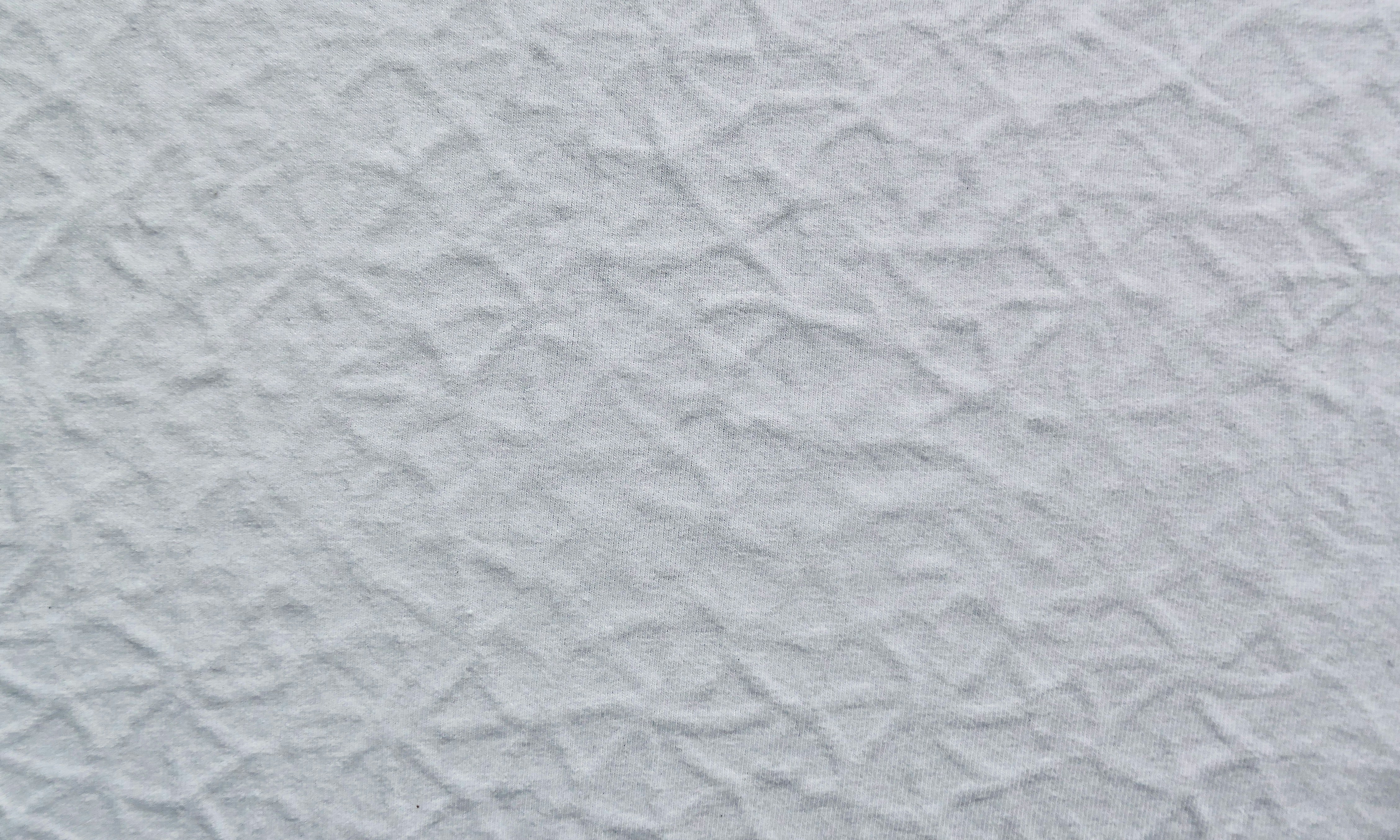 Close-up view of a textured white surface, showcasing intricate patterns that evoke a sense of calm and simplicity.