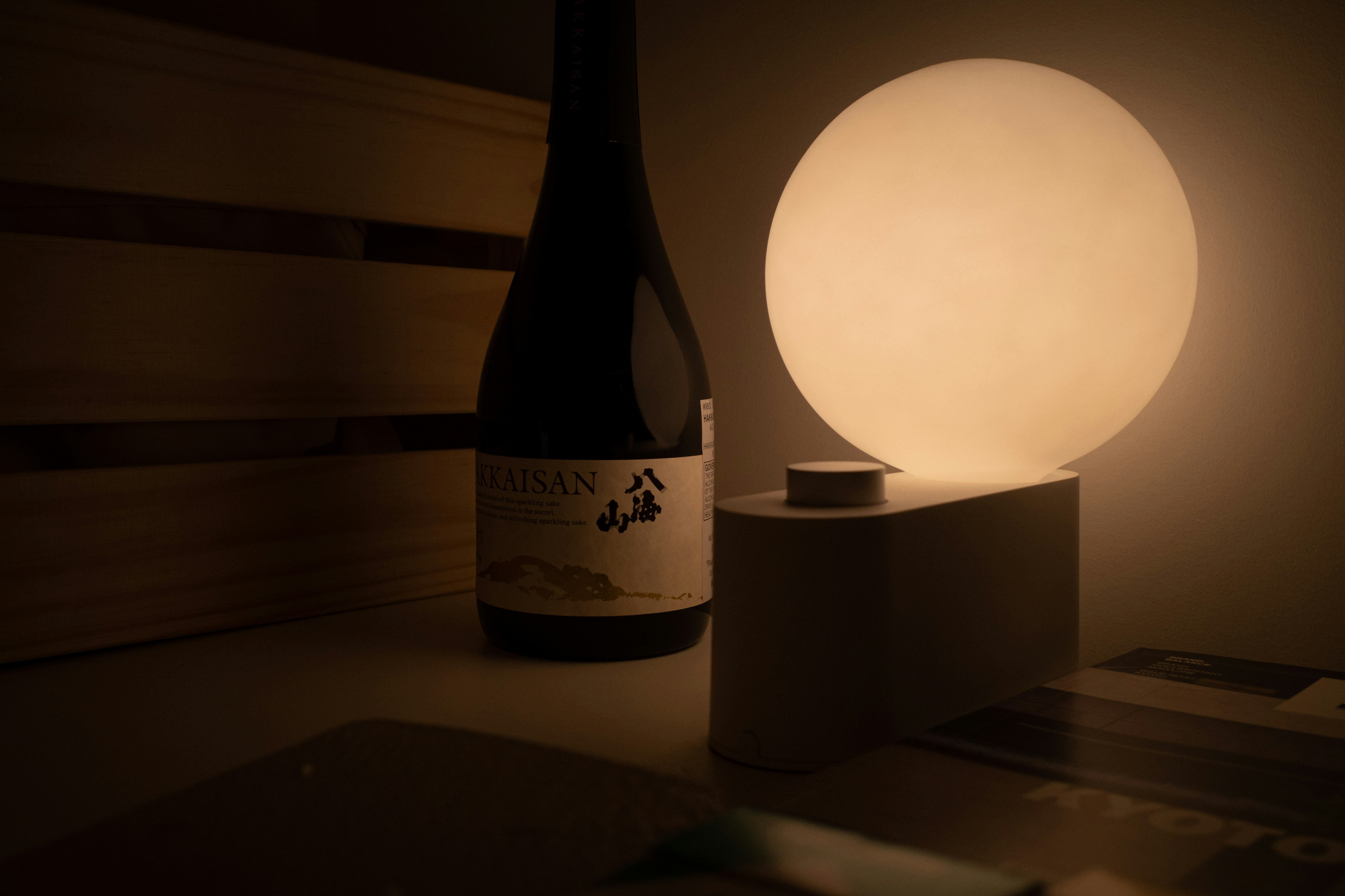 Amber Sphere and the Wine Bottle: A Quiet Studio Still Life
