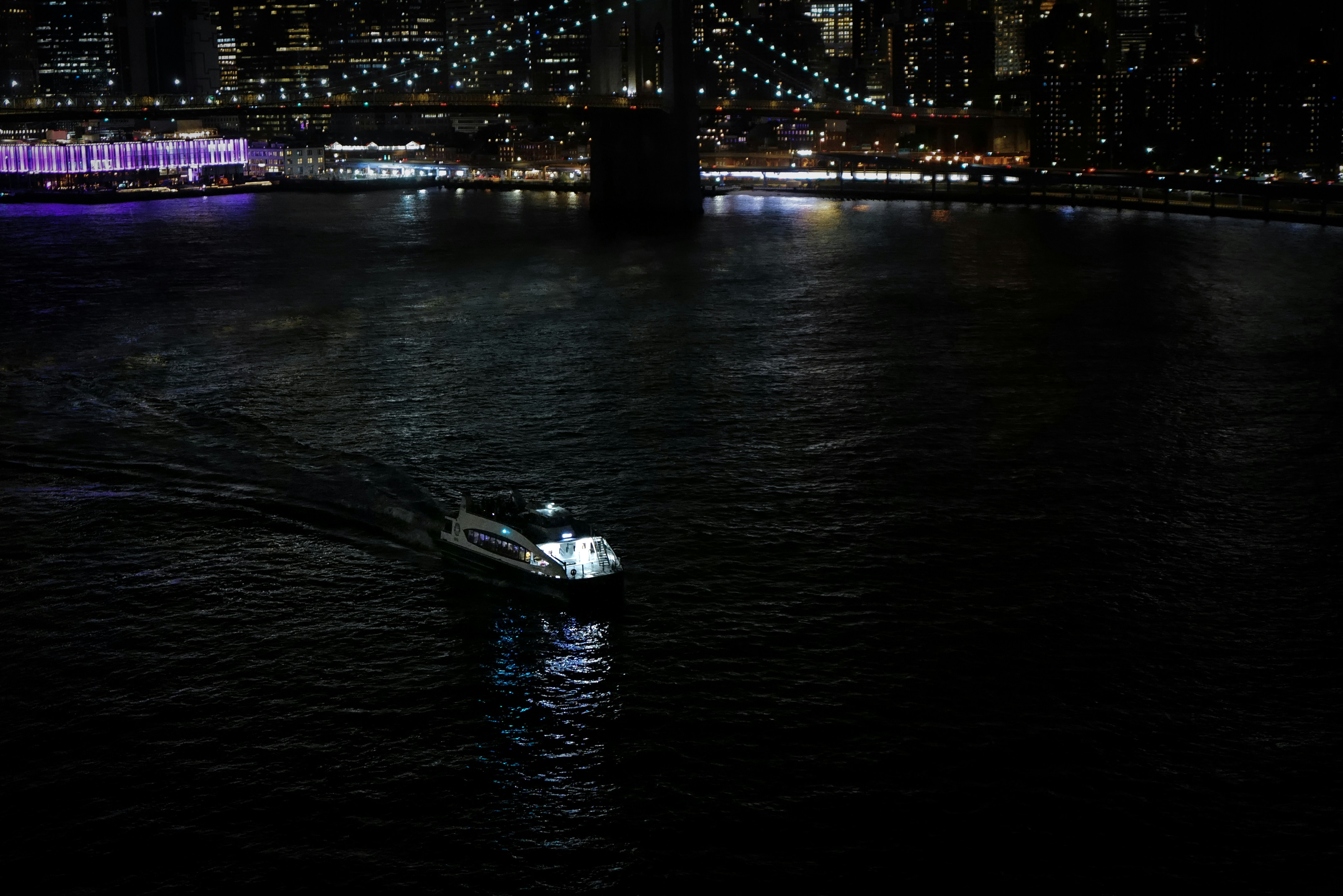 Night Ferry Gliding Under City Lights
