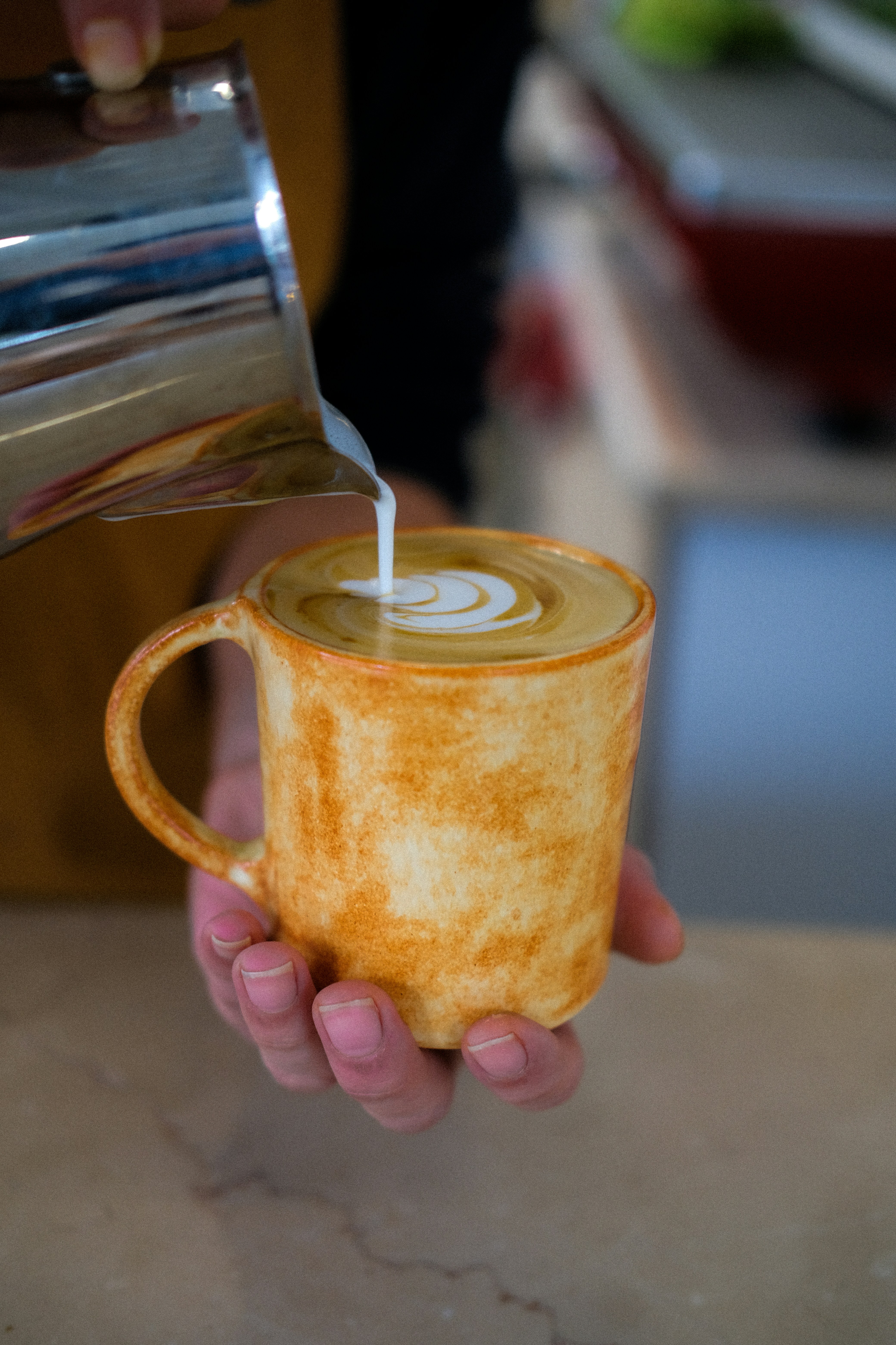 A person holding a cup with a liquid pouring out of it photo – Free Cup ...