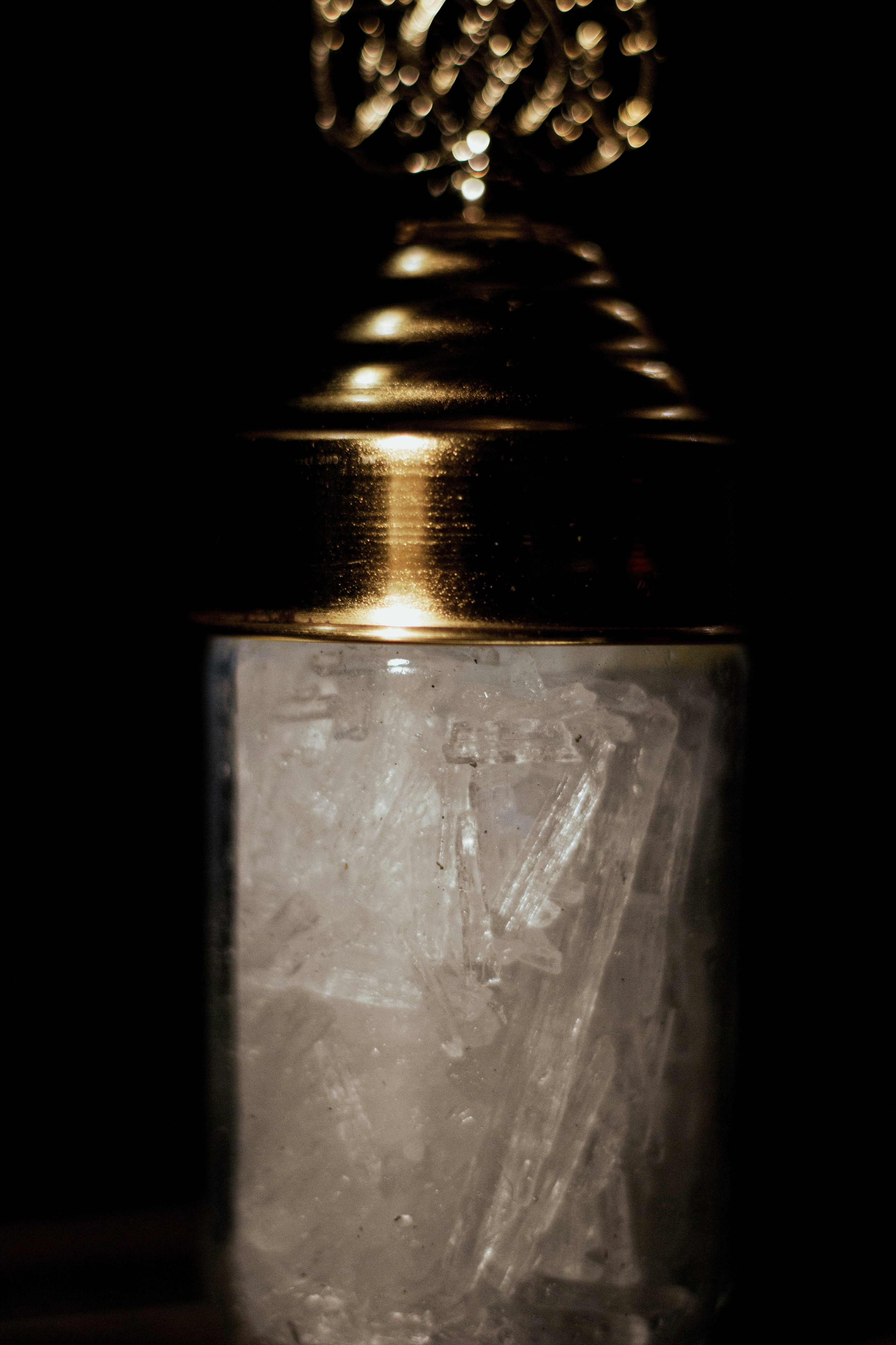 Gilded Frost: close-up of a frost-coated bottle bathed in amber glow