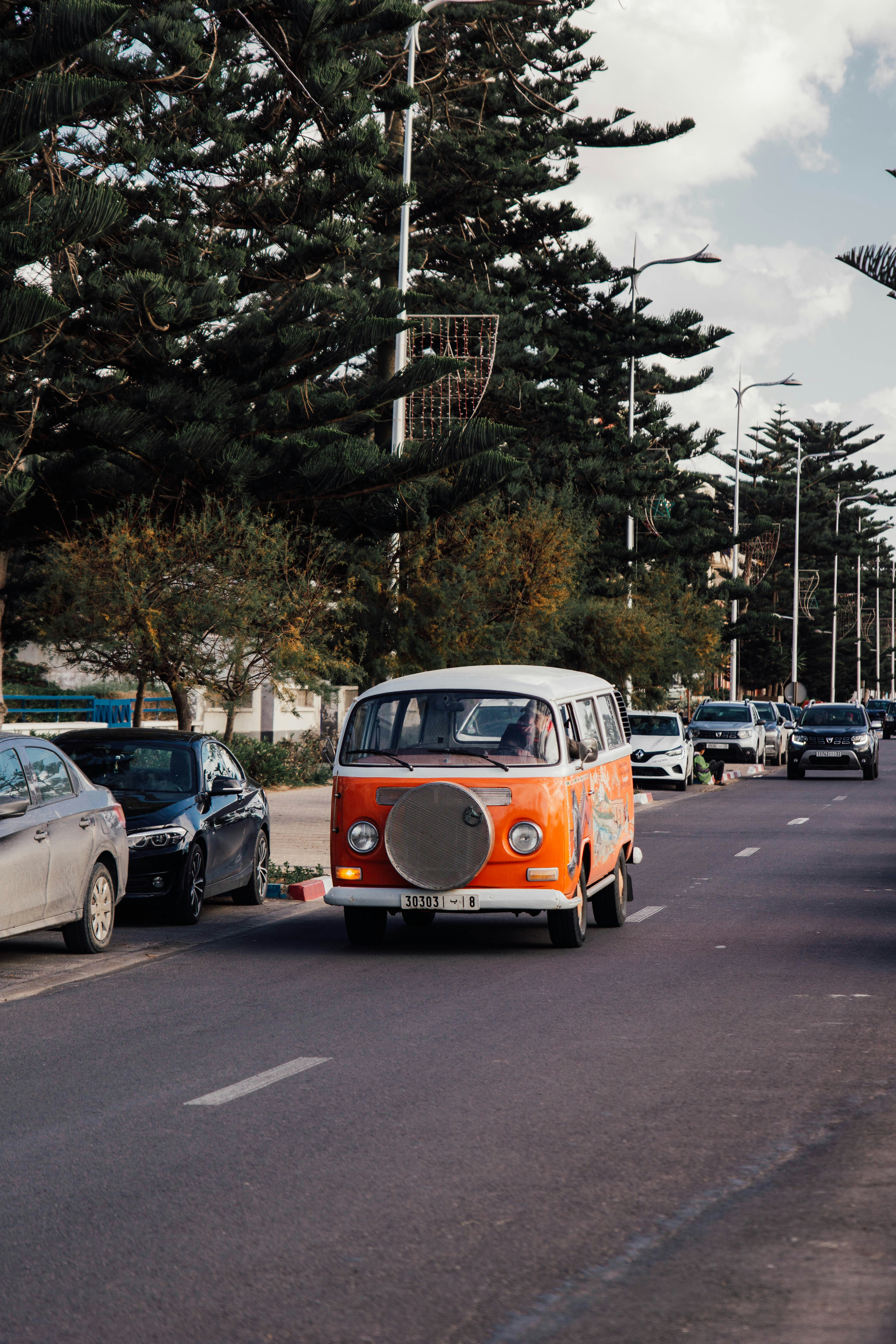 An orange and white van driving down a street photo – Free Marocco ...
