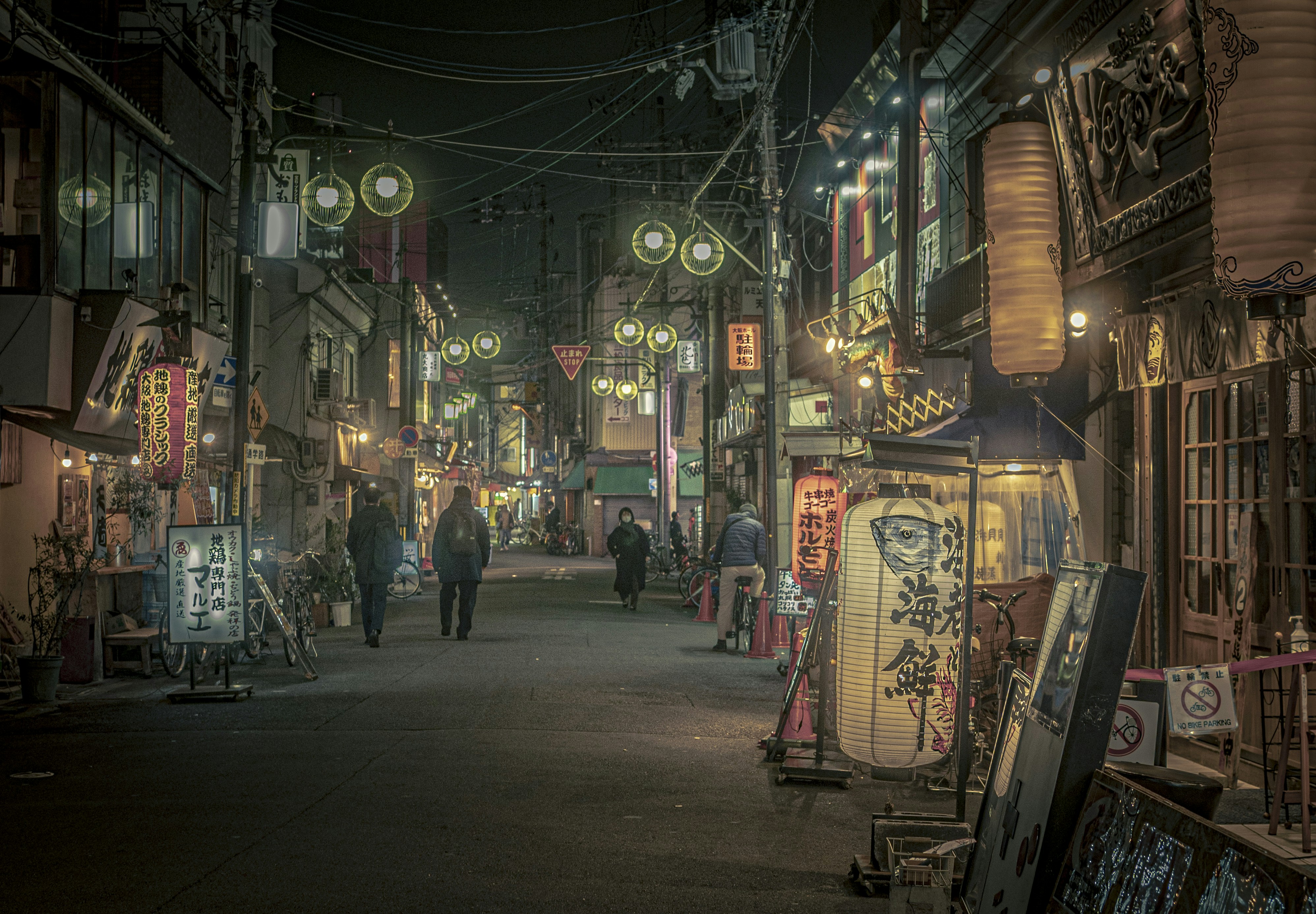 A city street filled with lots of shops at night photo – Free Urban ...