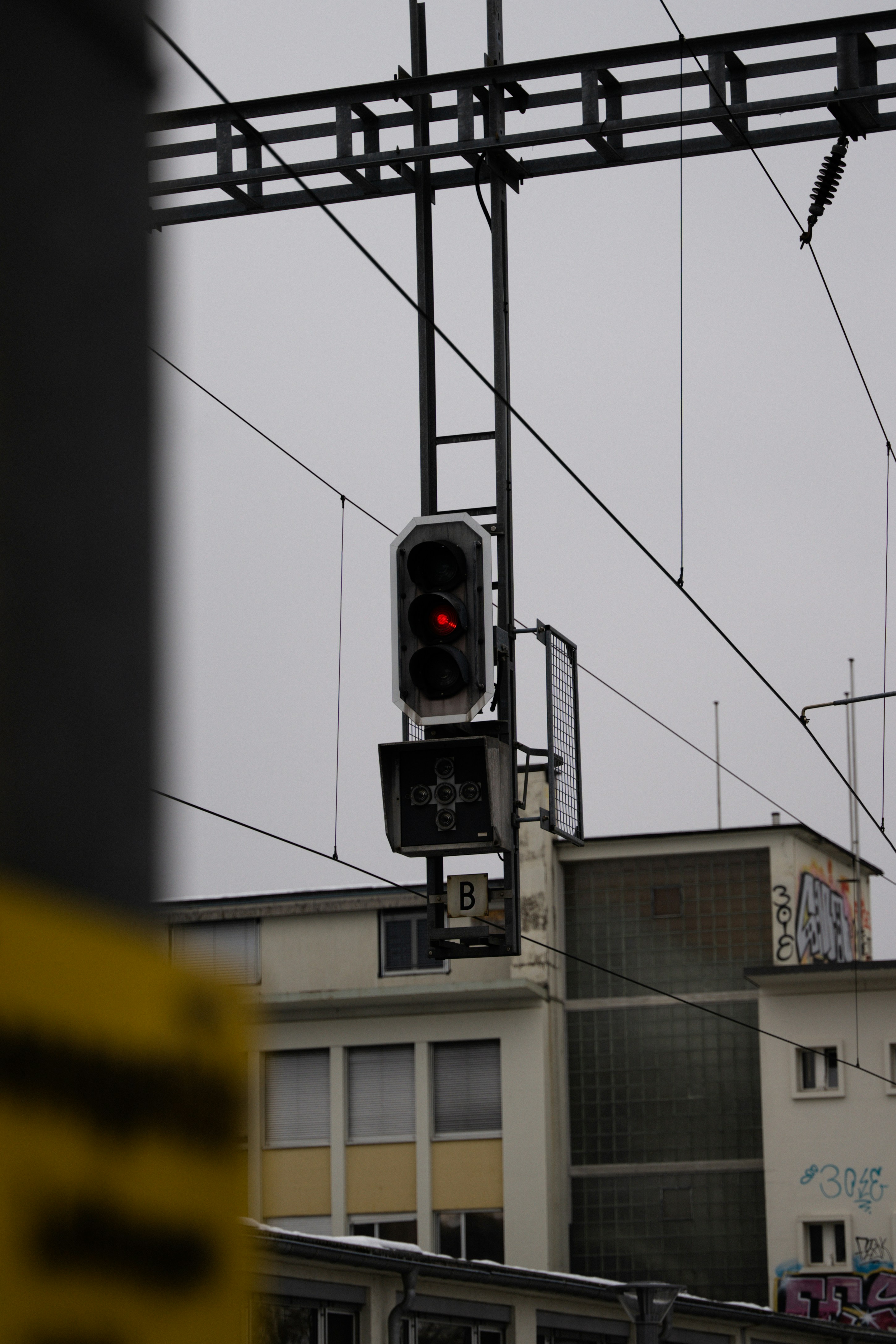 A traffic light hanging from the side of a building photo – Free Light ...