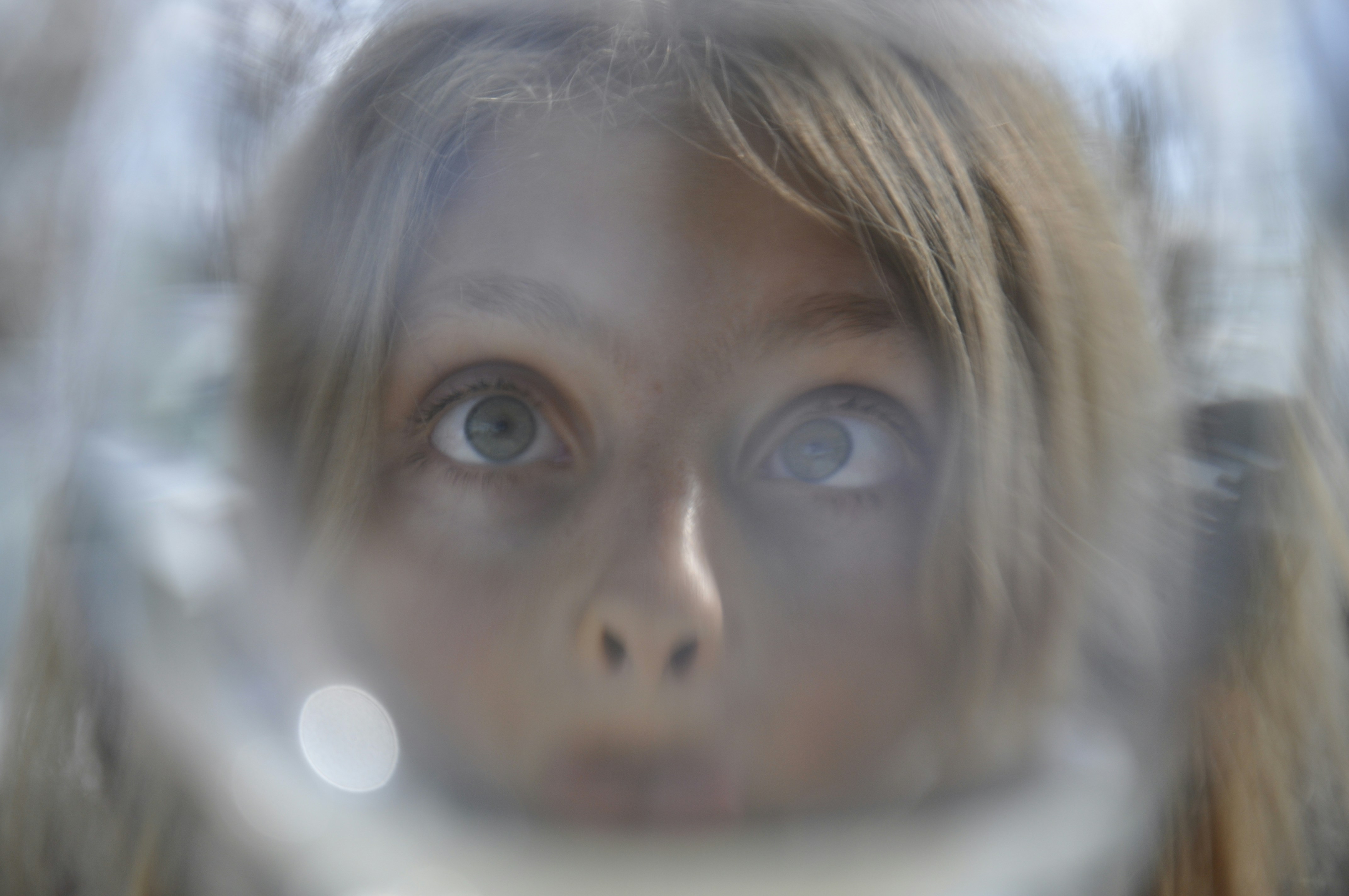 A close up of a person looking through a glass photo – Free Portrait ...