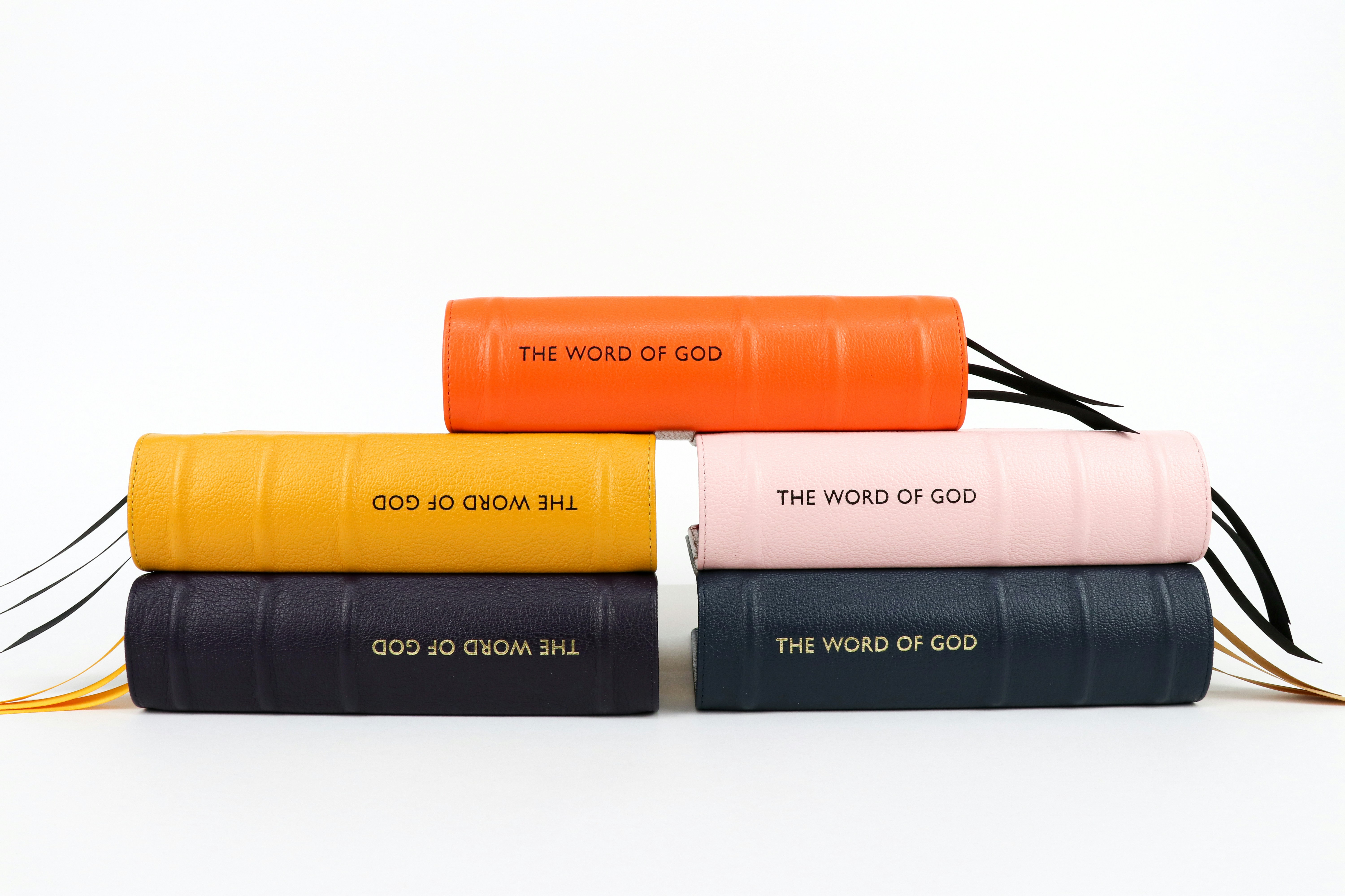 A stack of four books with the words the word of god written on them ...