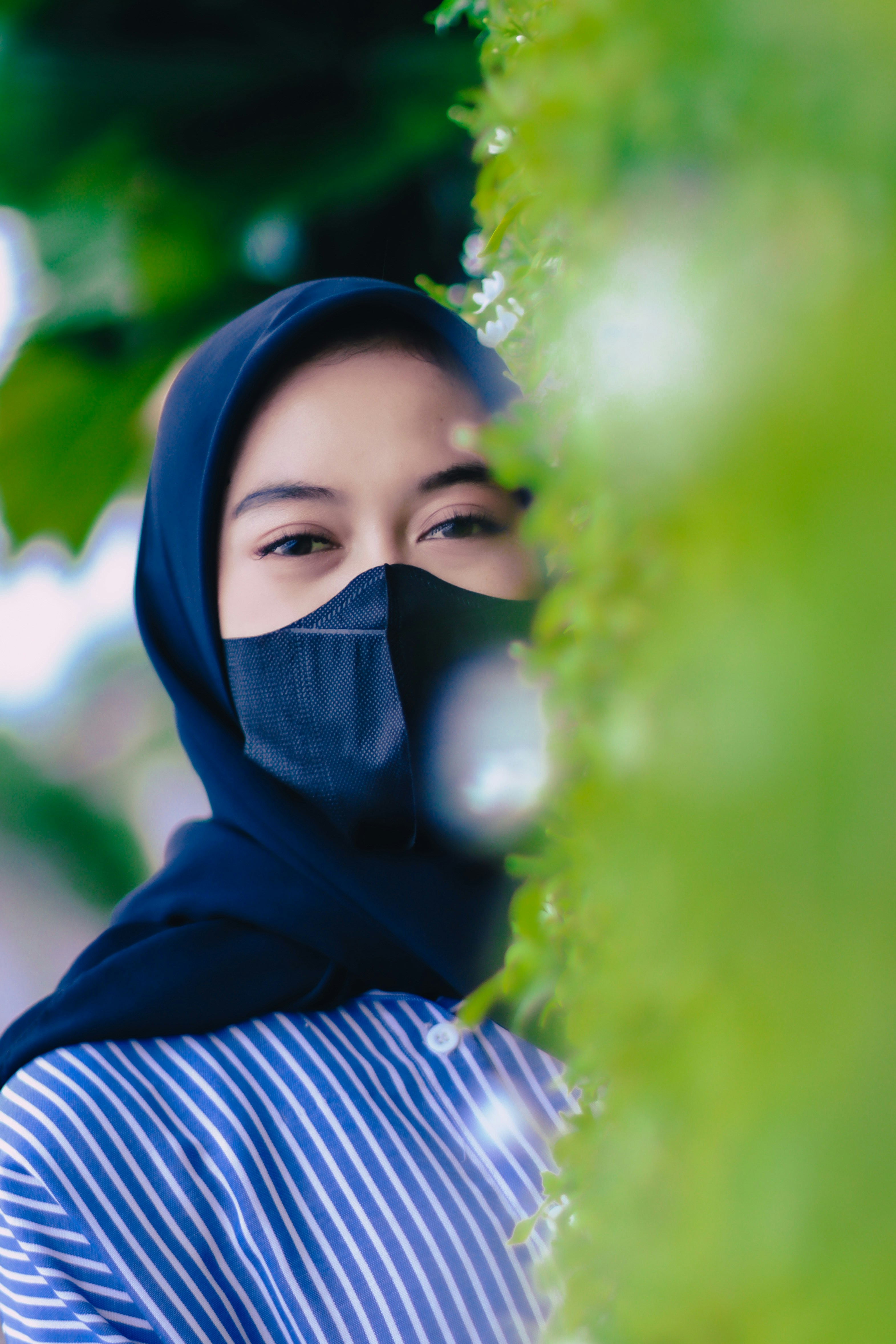A woman wearing a blue hijab and a black mask photo – Free Muslimah ...