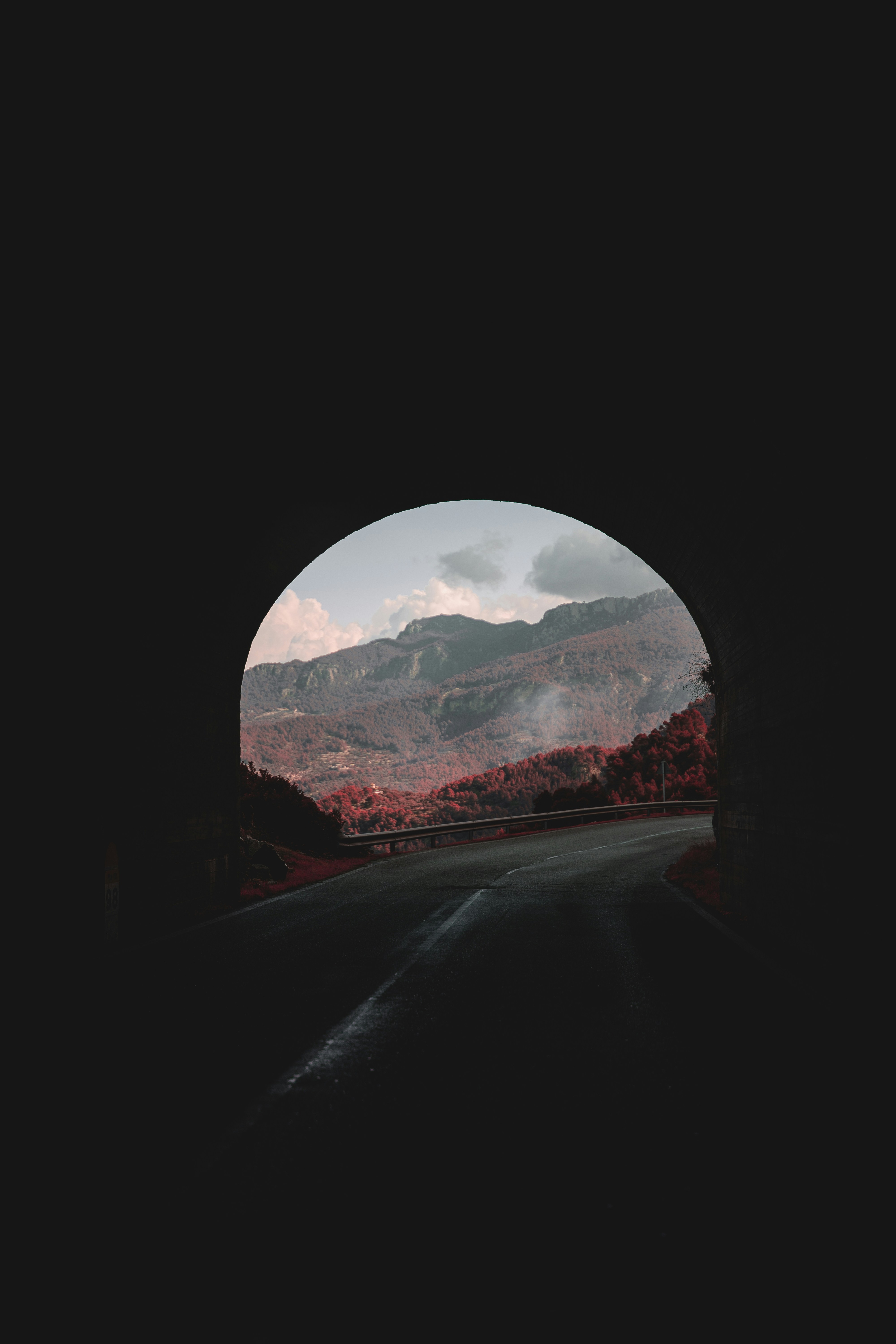 Portal of Light: A Mountain Road Framed by a Tunnel