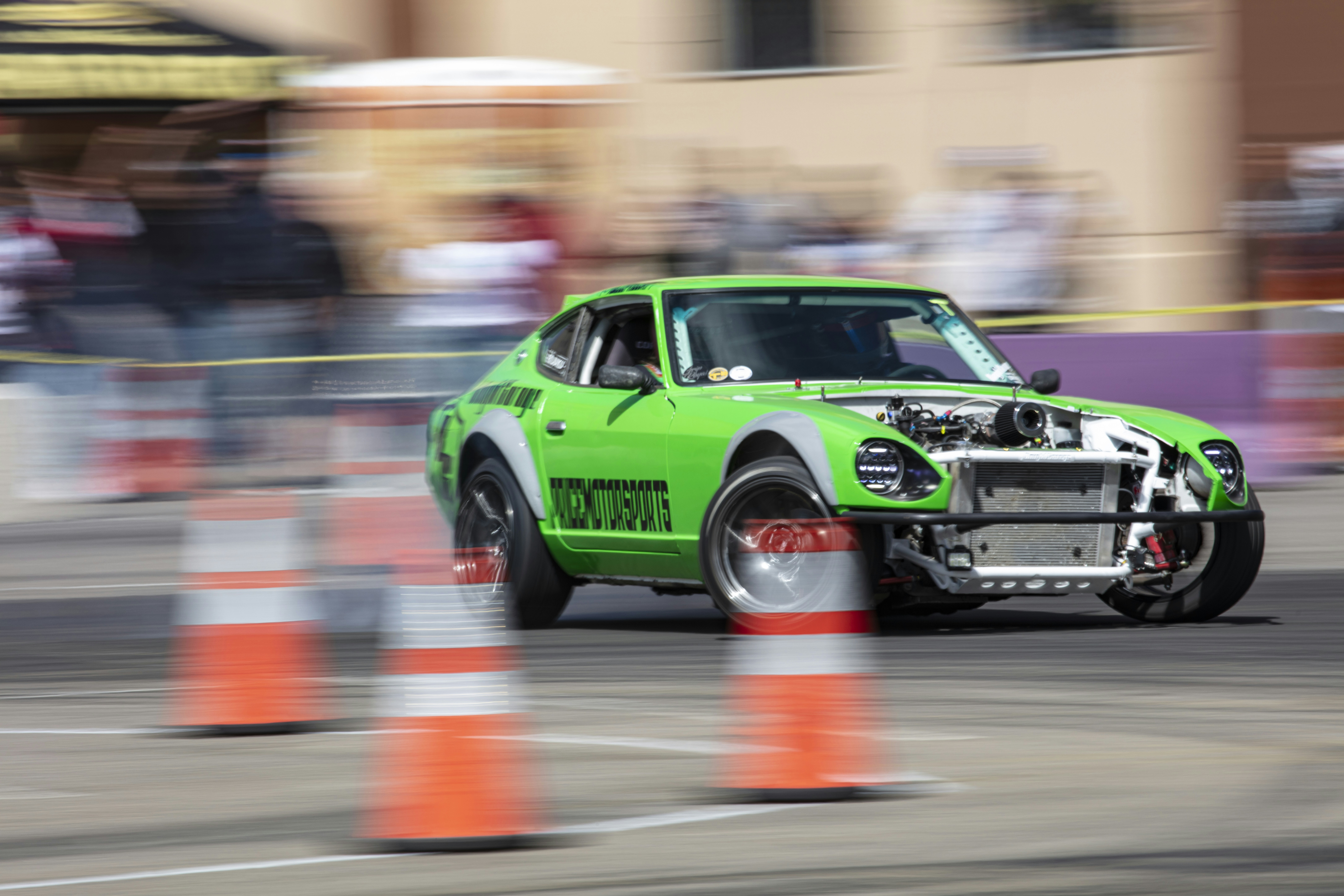 A green car driving down a race track photo – Free Drift Image on Unsplash