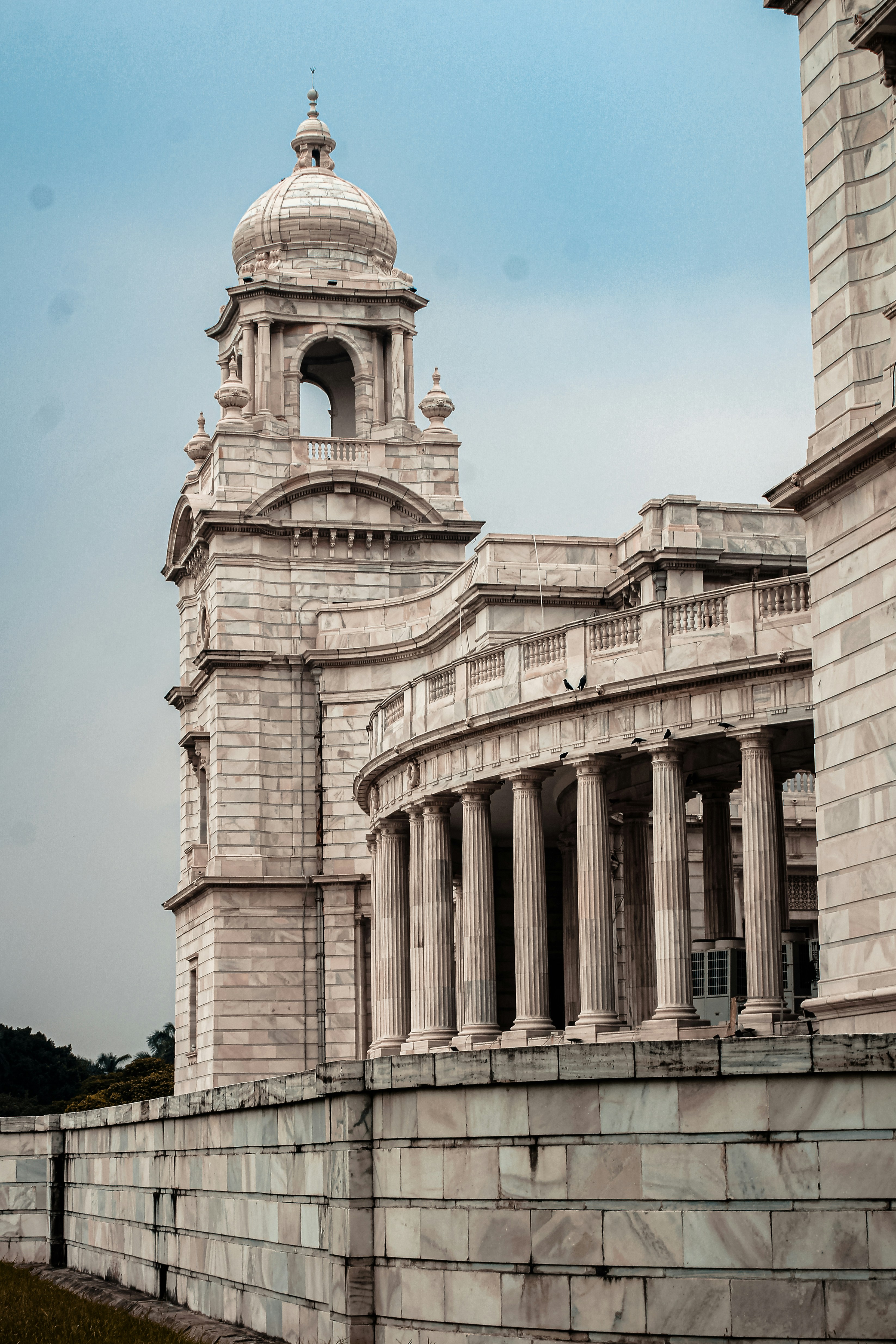 Historic building featuring grand columns and a prominent dome, showcasing intricate architectural details against a serene sky.