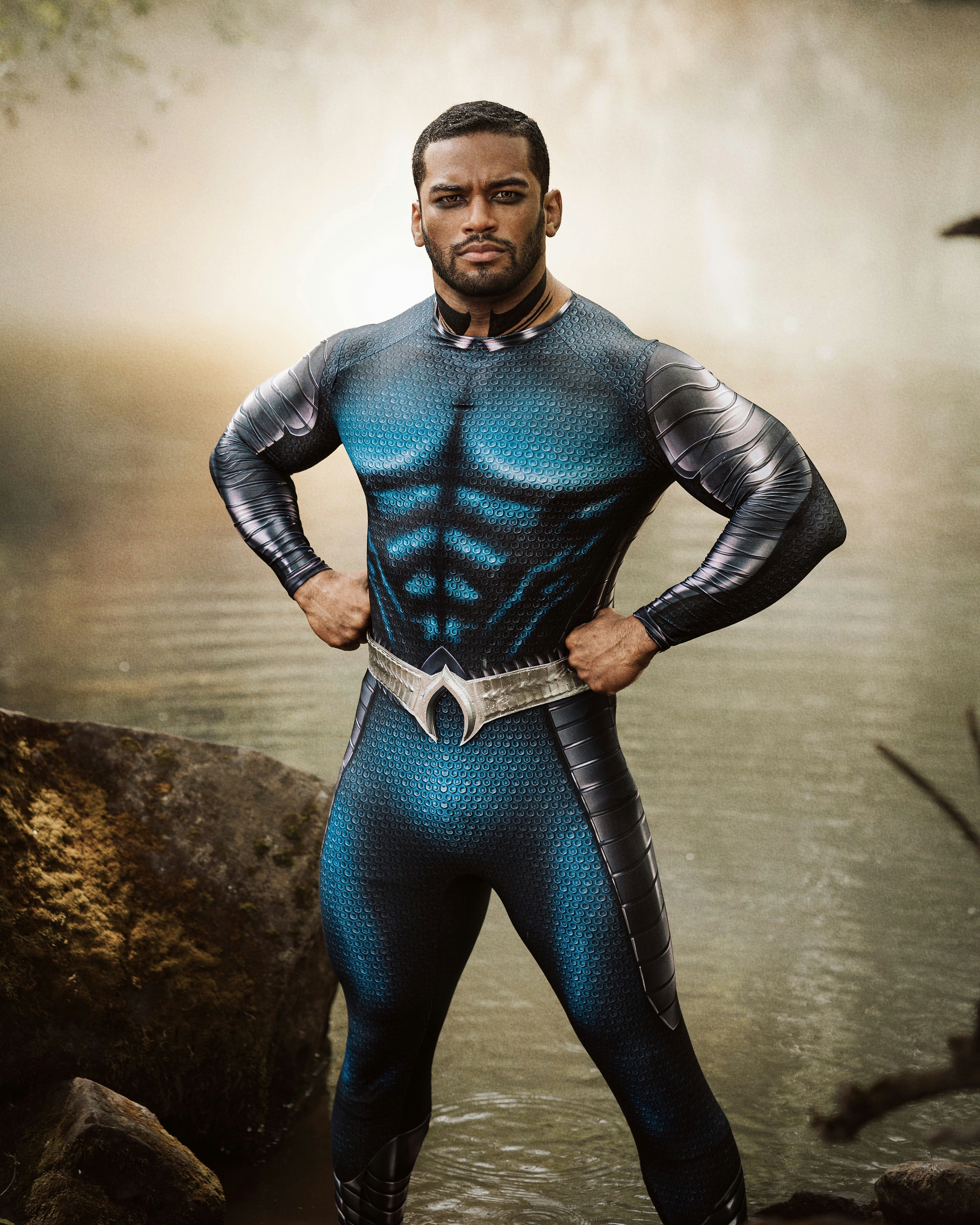 A man in a blue and black suit standing in water photo – Free Portland ...