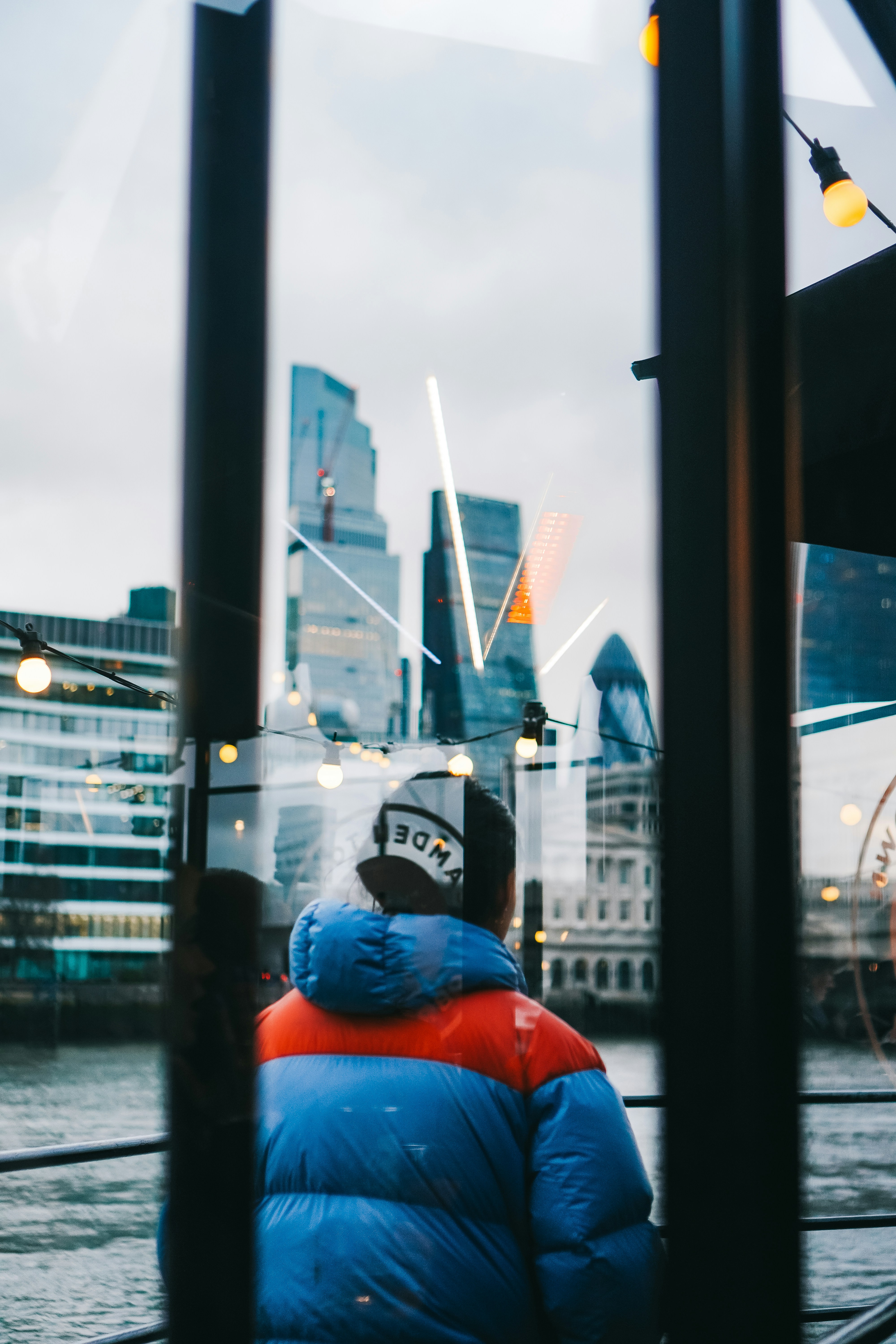 Blue-Pinned Winter Jacket with City Skyline Reflections
