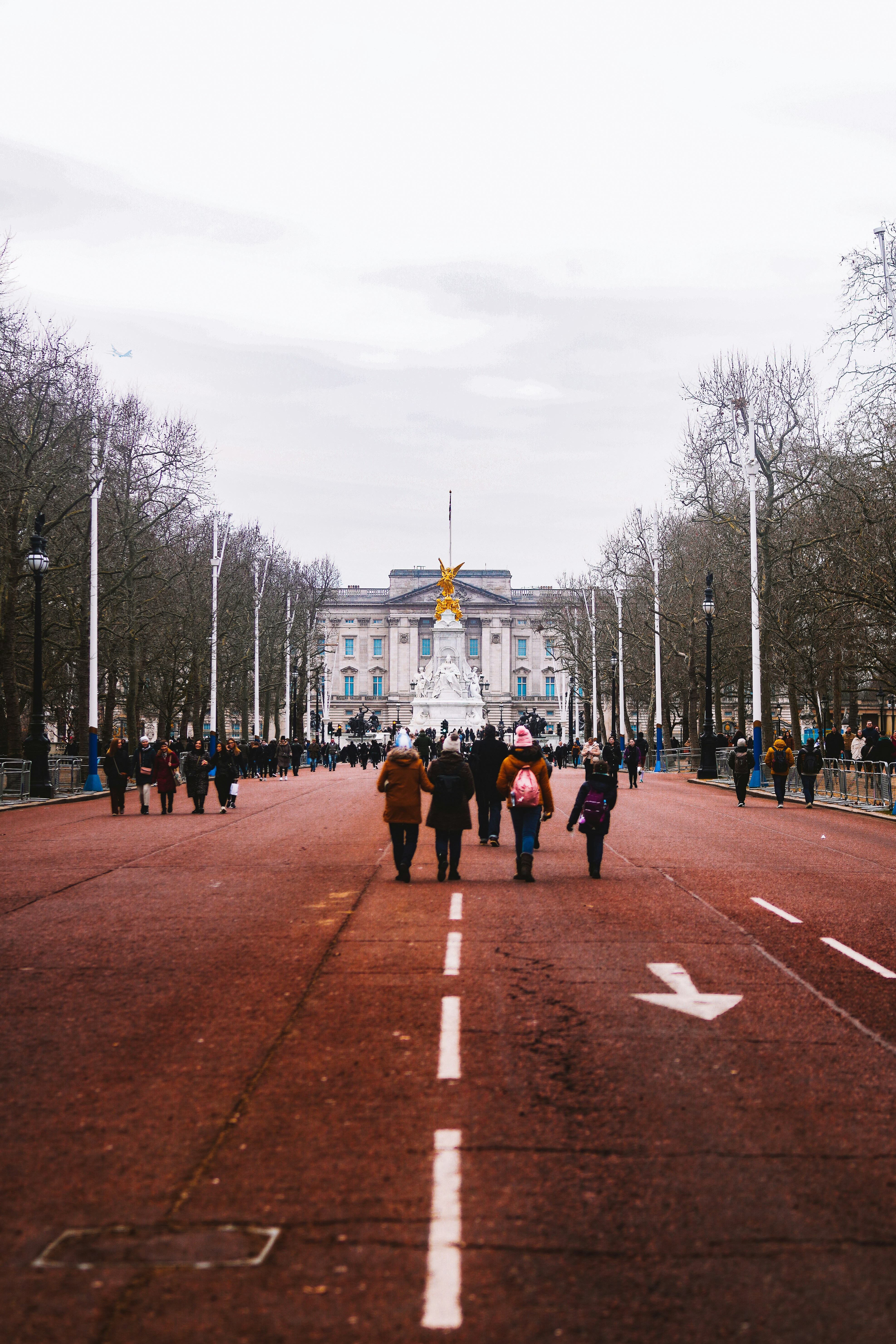 Golden Star on the City Square: Pedestrians Converge Along a Red Avenue