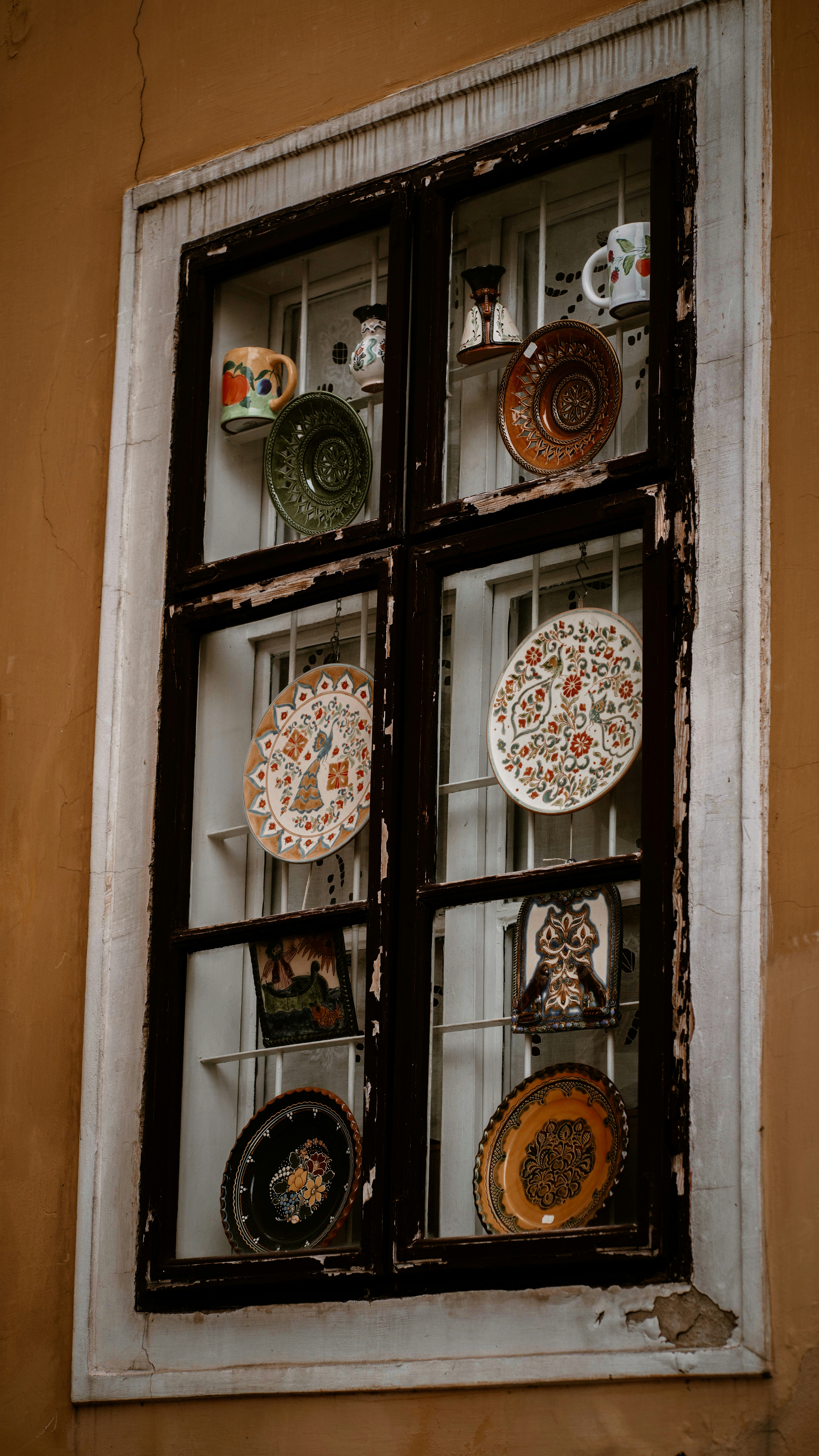 A window that has a bunch of plates in it photo – Free Cup Image on ...