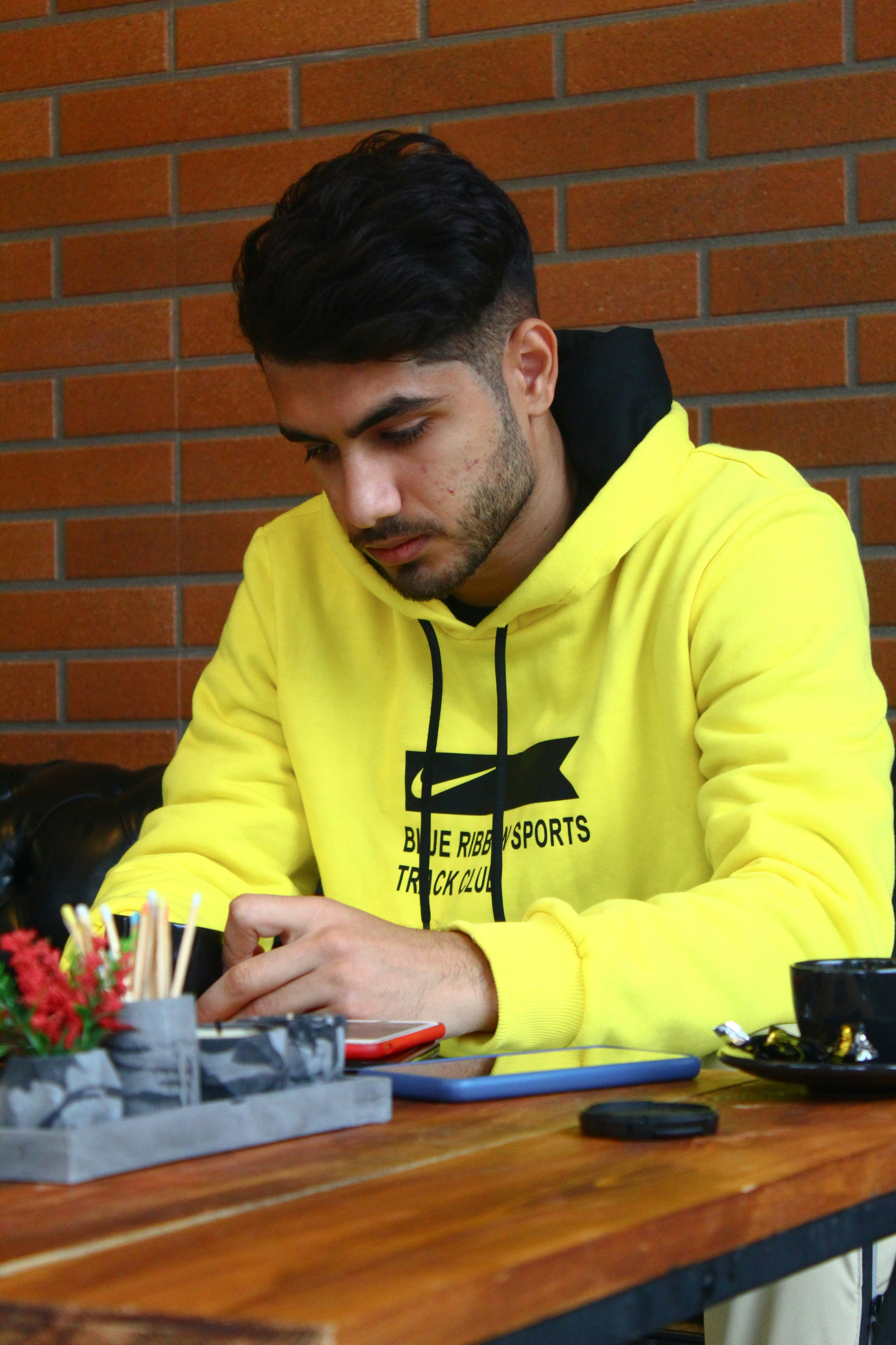 Focused Moment: A Quiet Pause with a Bright Hoodie