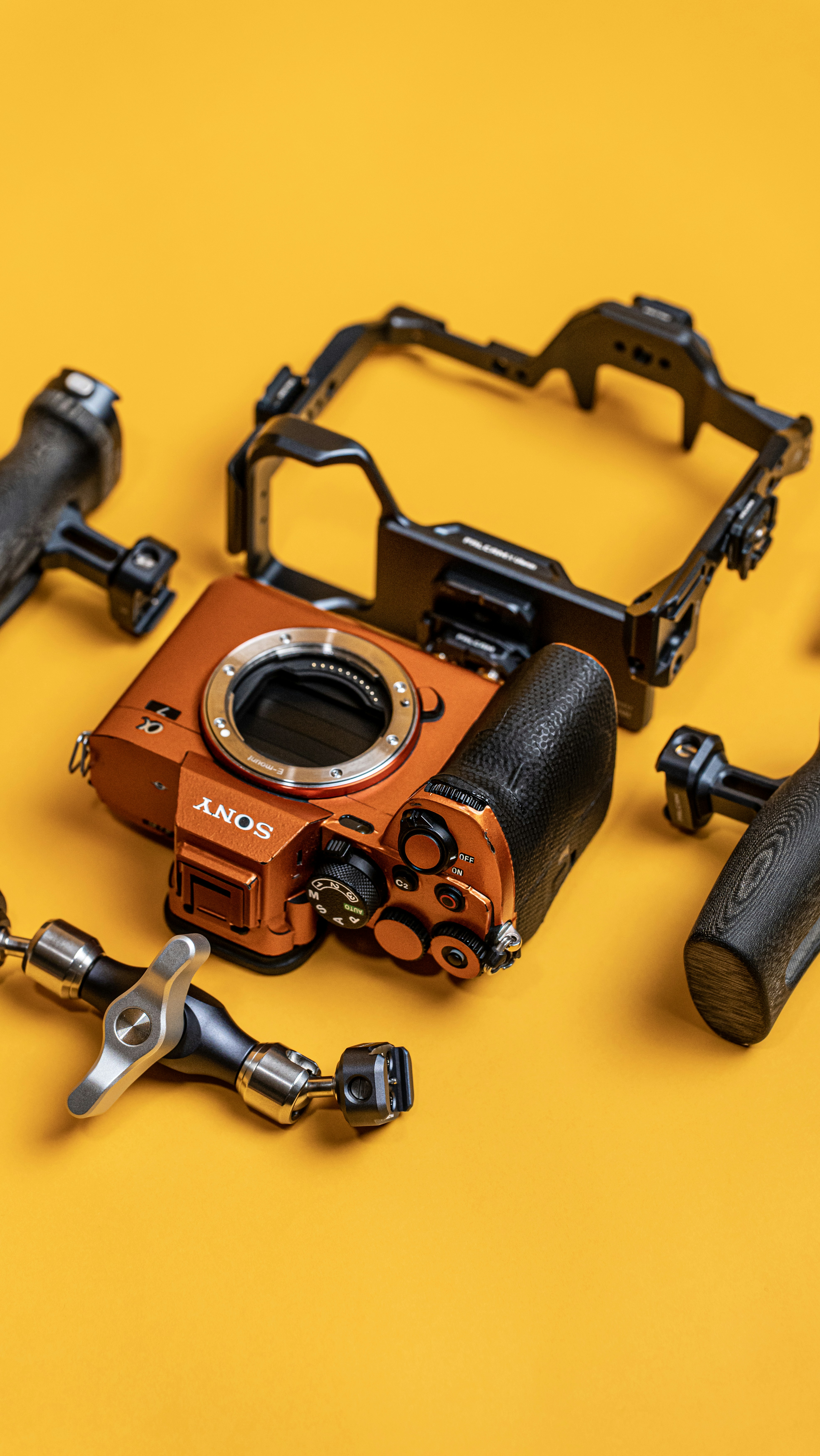 Orange Sony A7 Case: Disassembled Kit Lays Bare on Vibrant Yellow