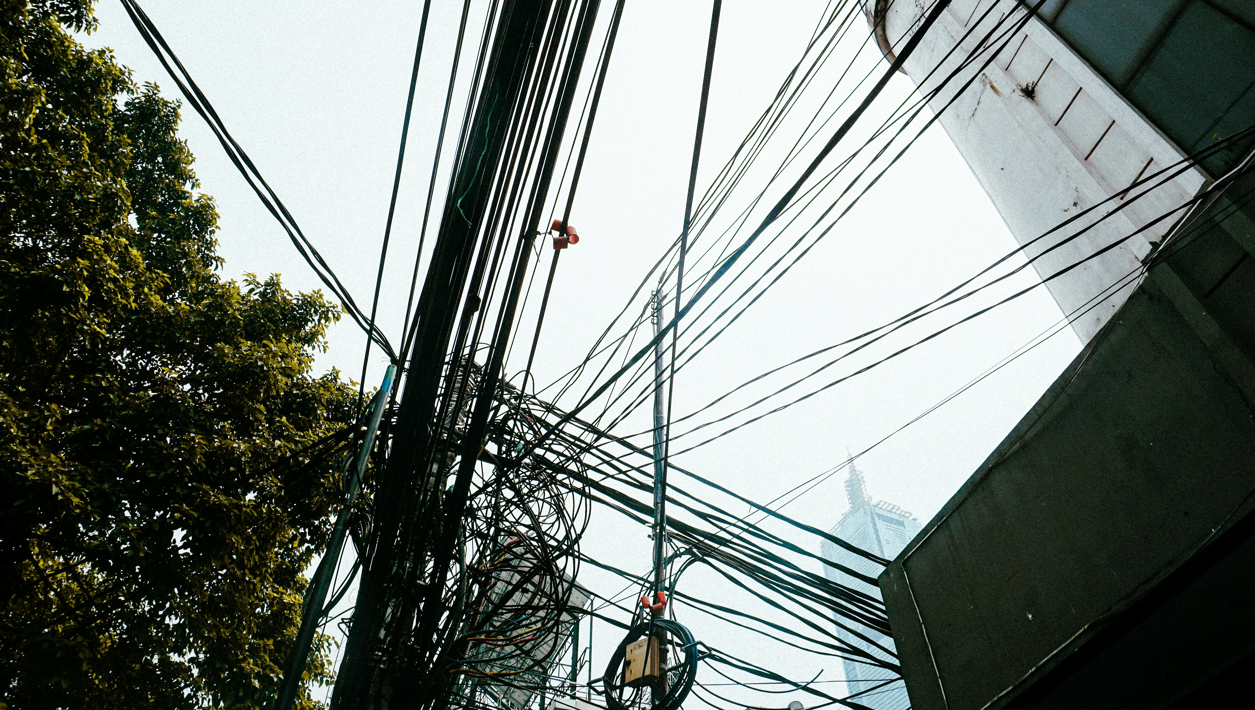 A telephone pole with wires and wires hanging from it photo – Free Sky ...