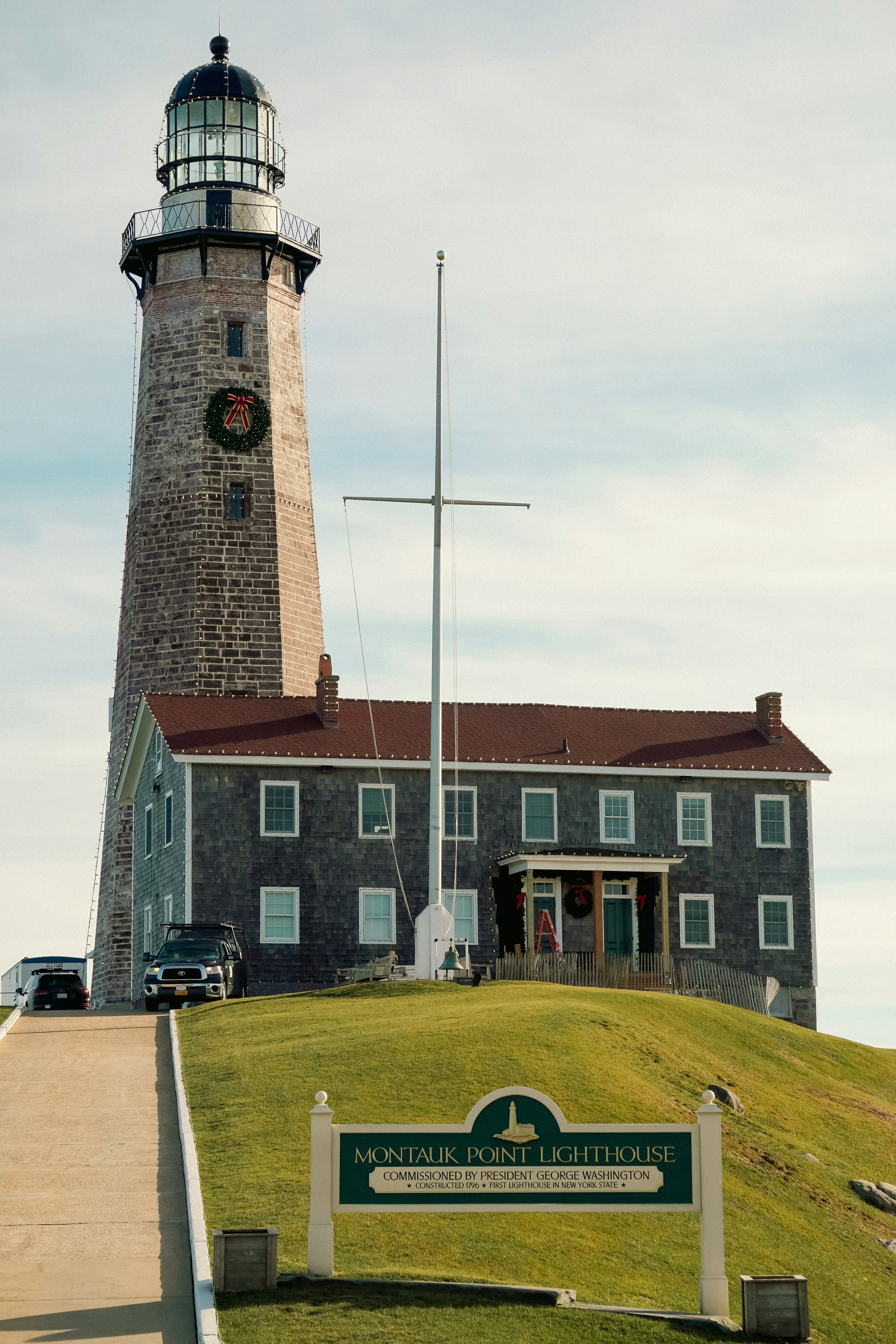 a lighthouse with a sign in front of it