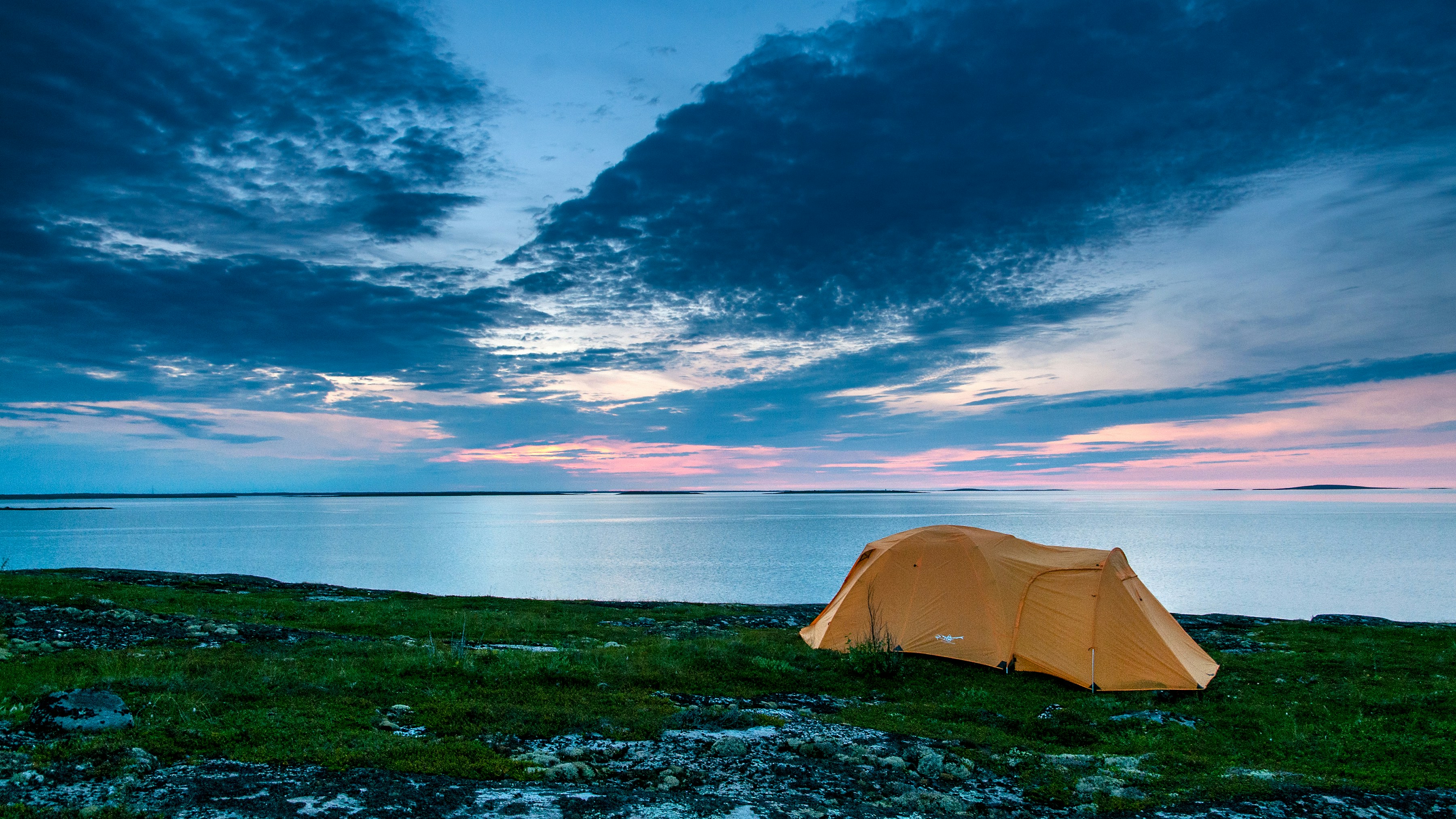 Amber Shelter on the Quiet Shore at Blue Hour