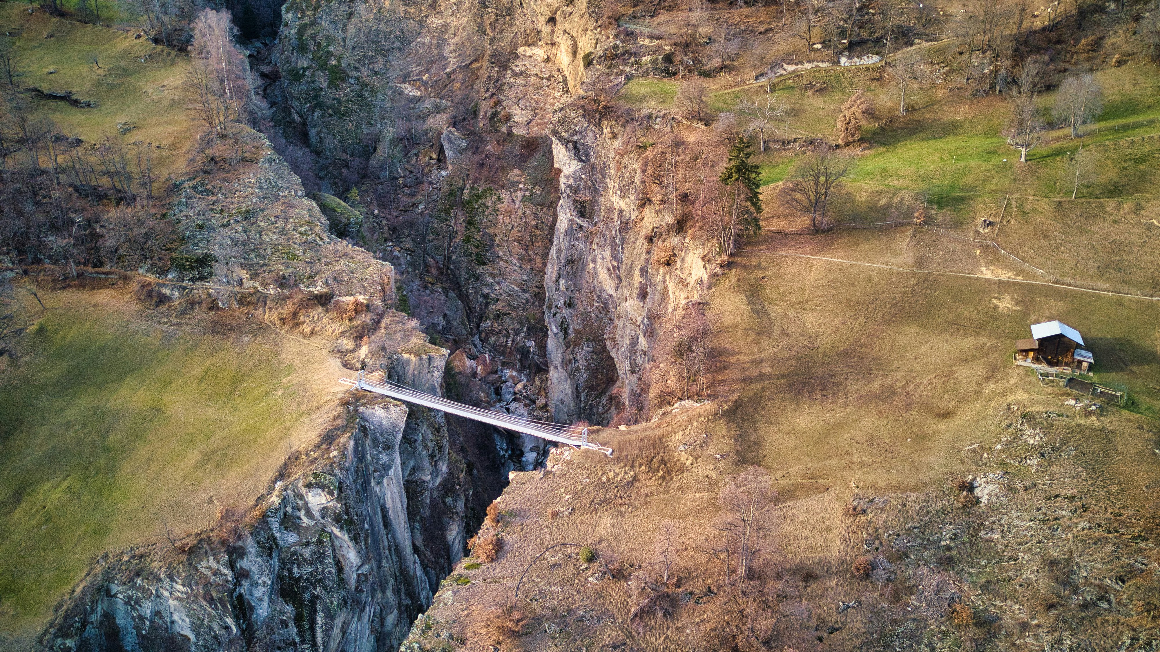 an aerial view of a bridge over a canyon
