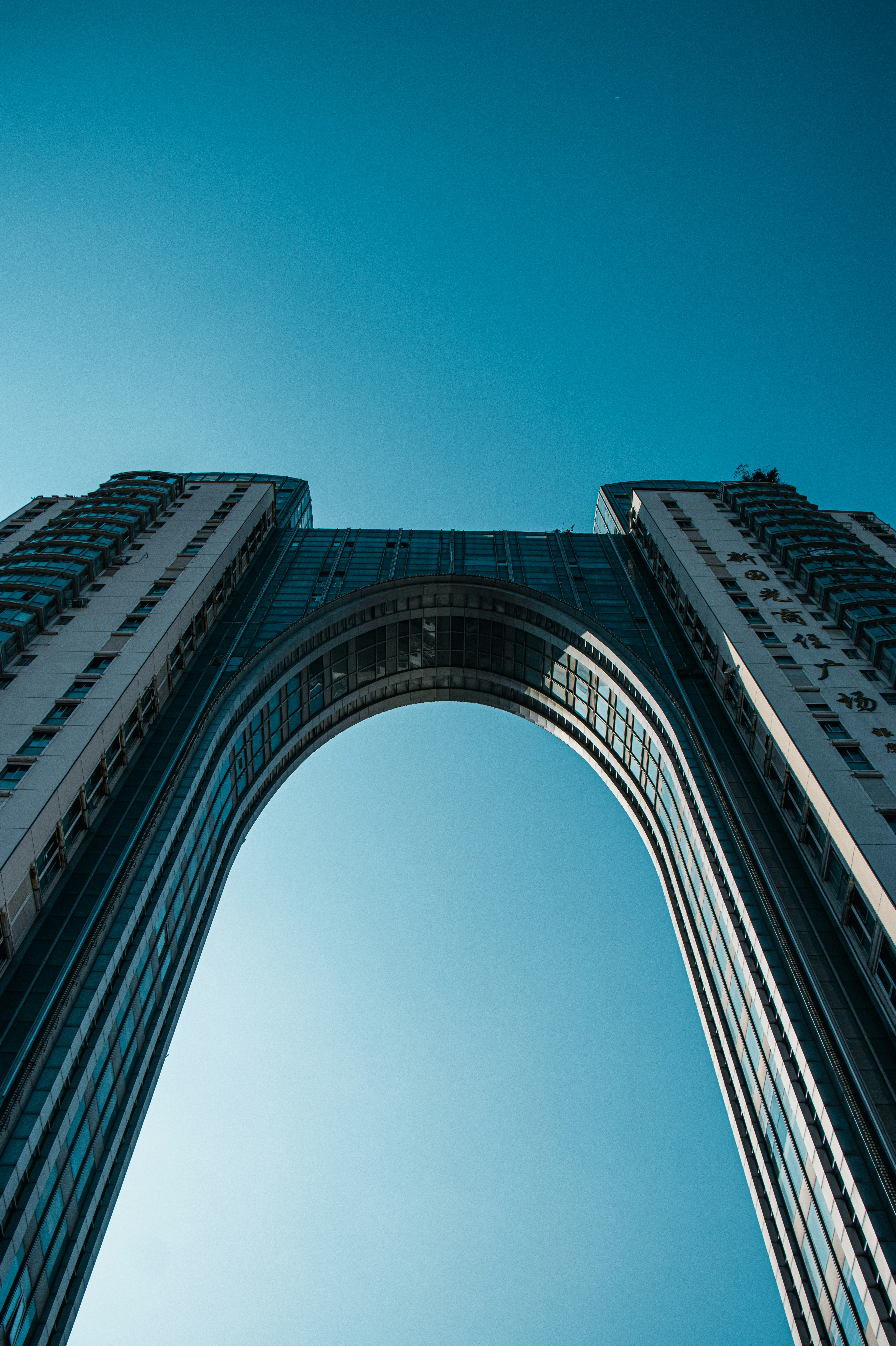 Azure Archway: Twin Towers Framing a Skyward Gateway