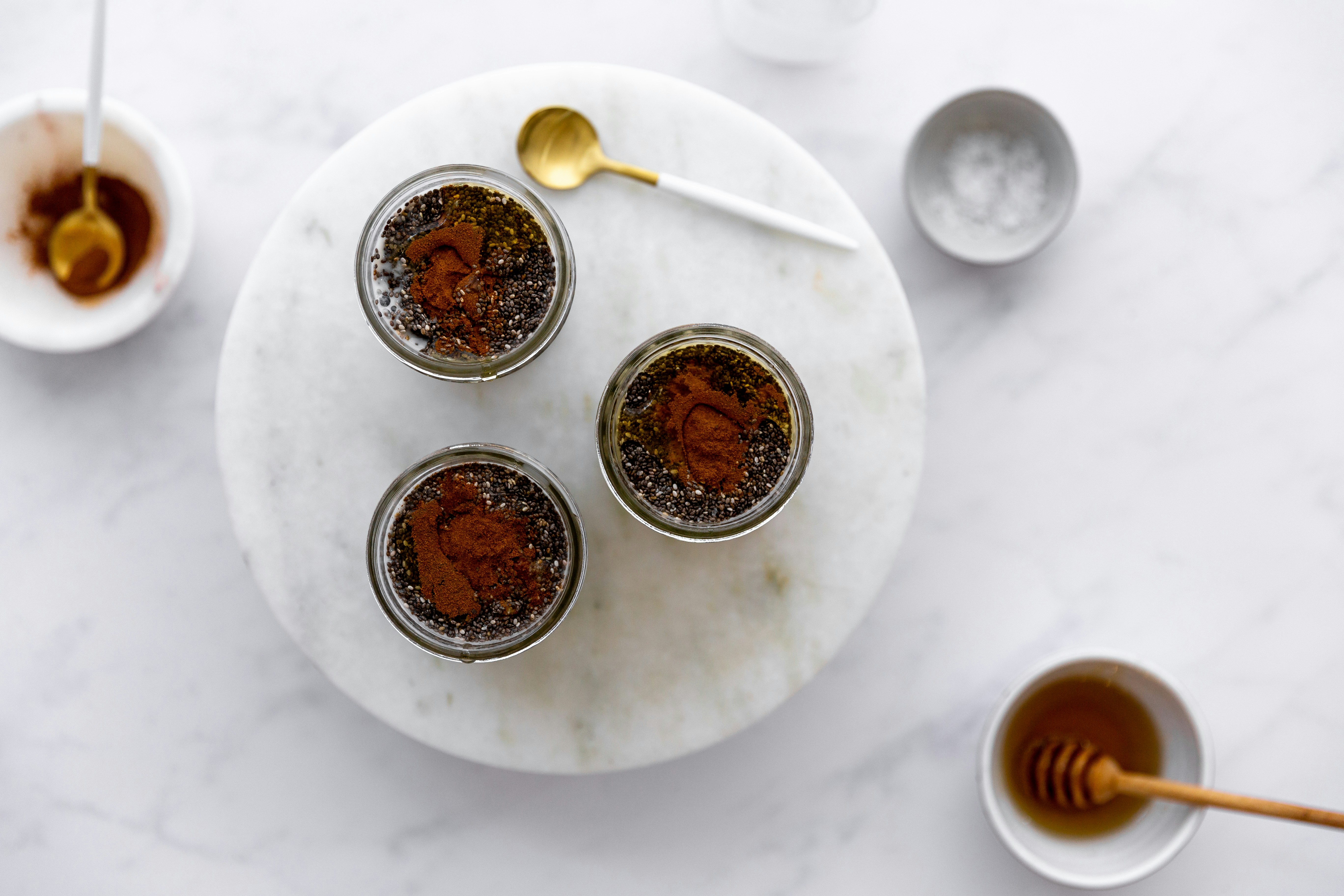 A marble plate topped with four cups filled with pudding photo – Free ...