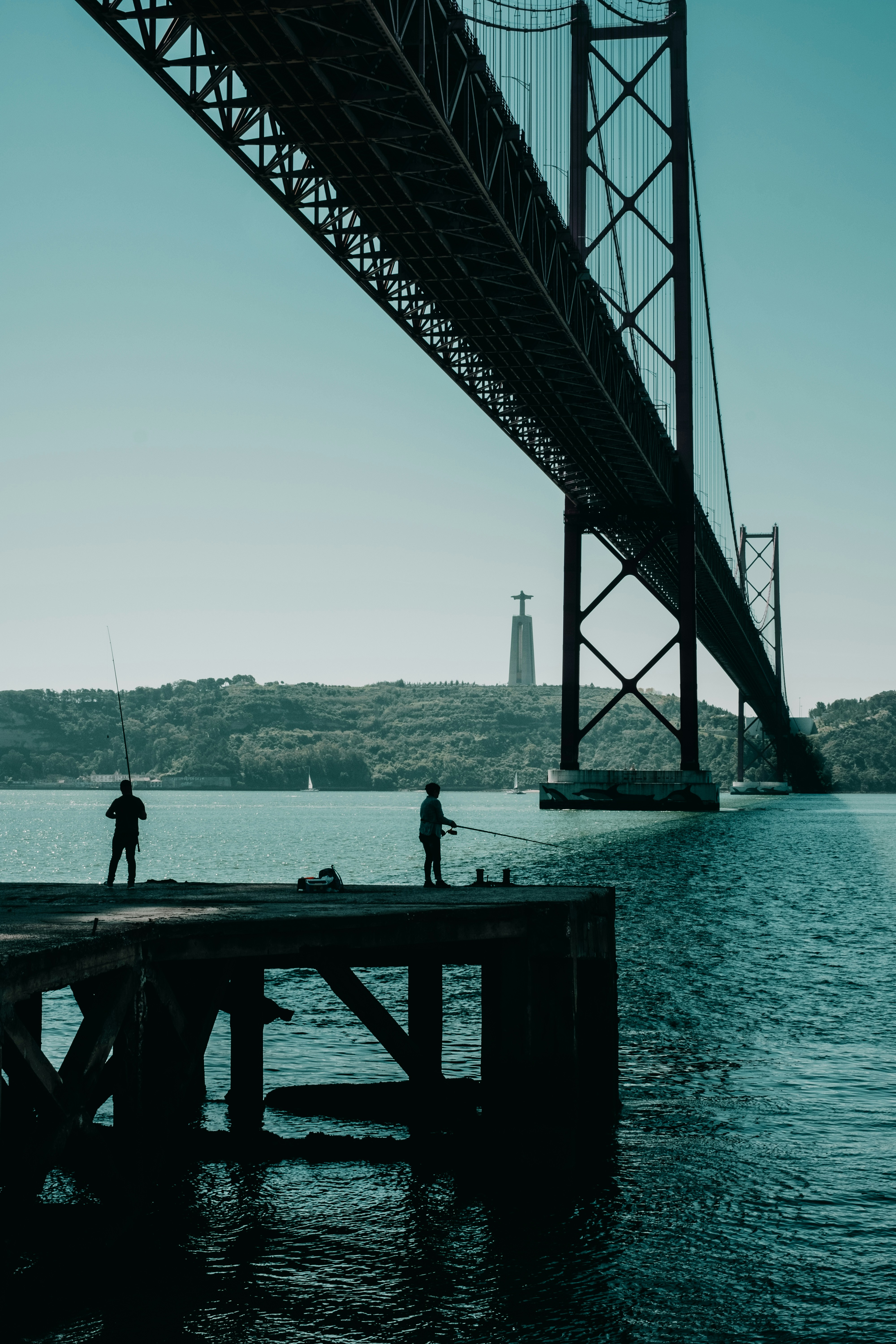 Bridge to Quiet Waters: Fishermen at Distant Pier