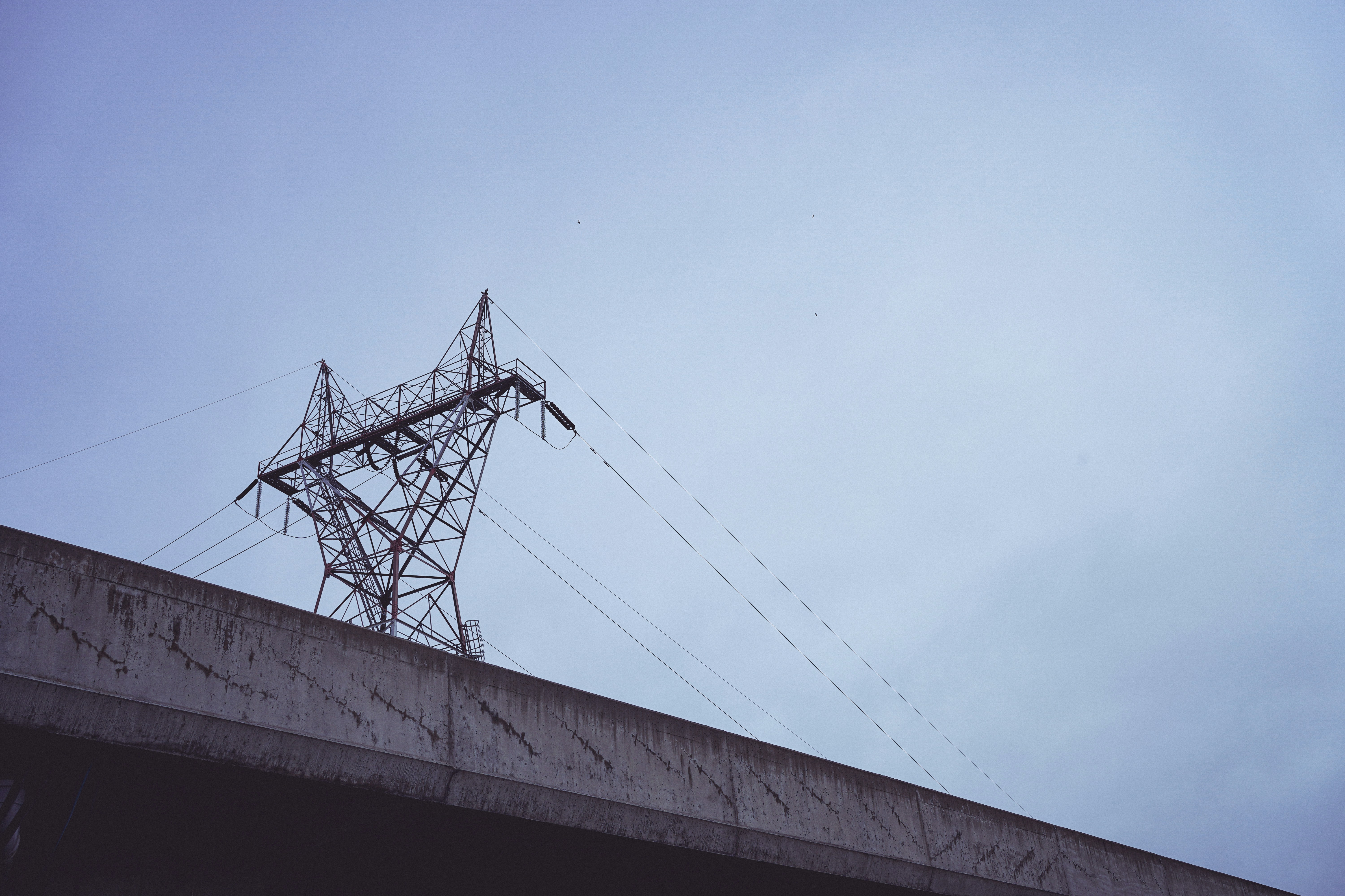 A high voltage power line on top of a building photo – Free Pedestrian ...
