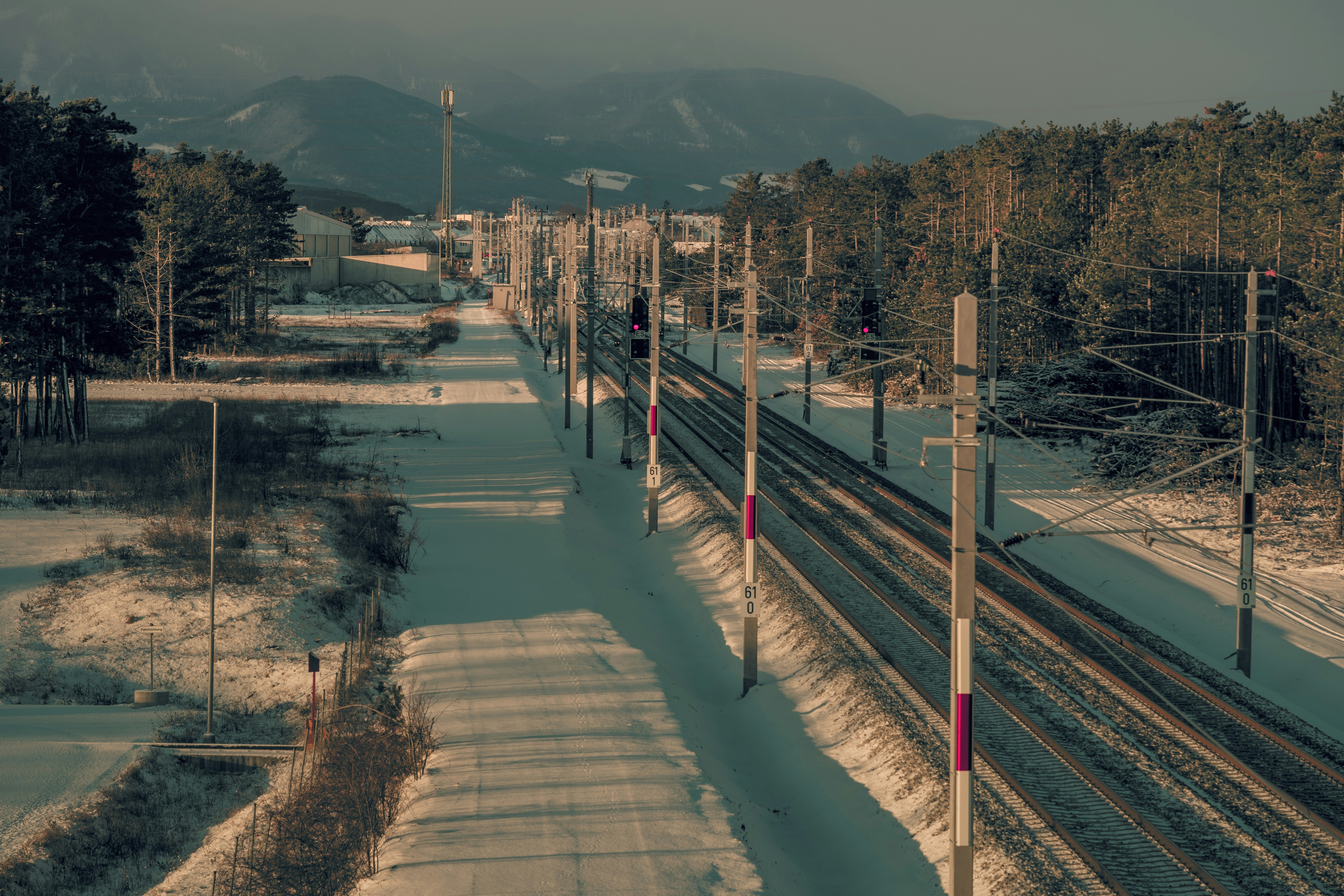 A train track running through a snow covered forest photo – Free Forest ...