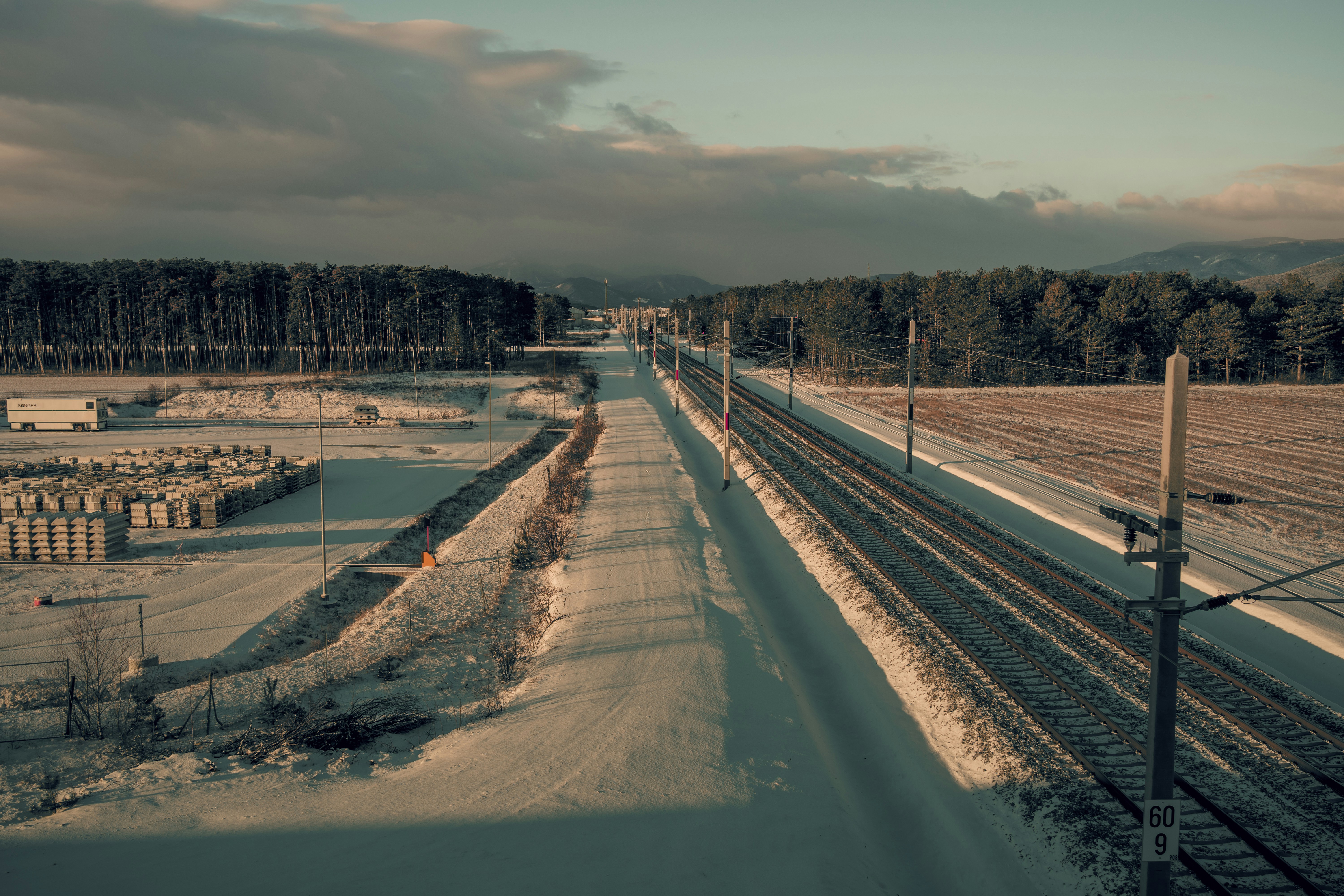 Converging Rails through a Snow-Washed Landscape