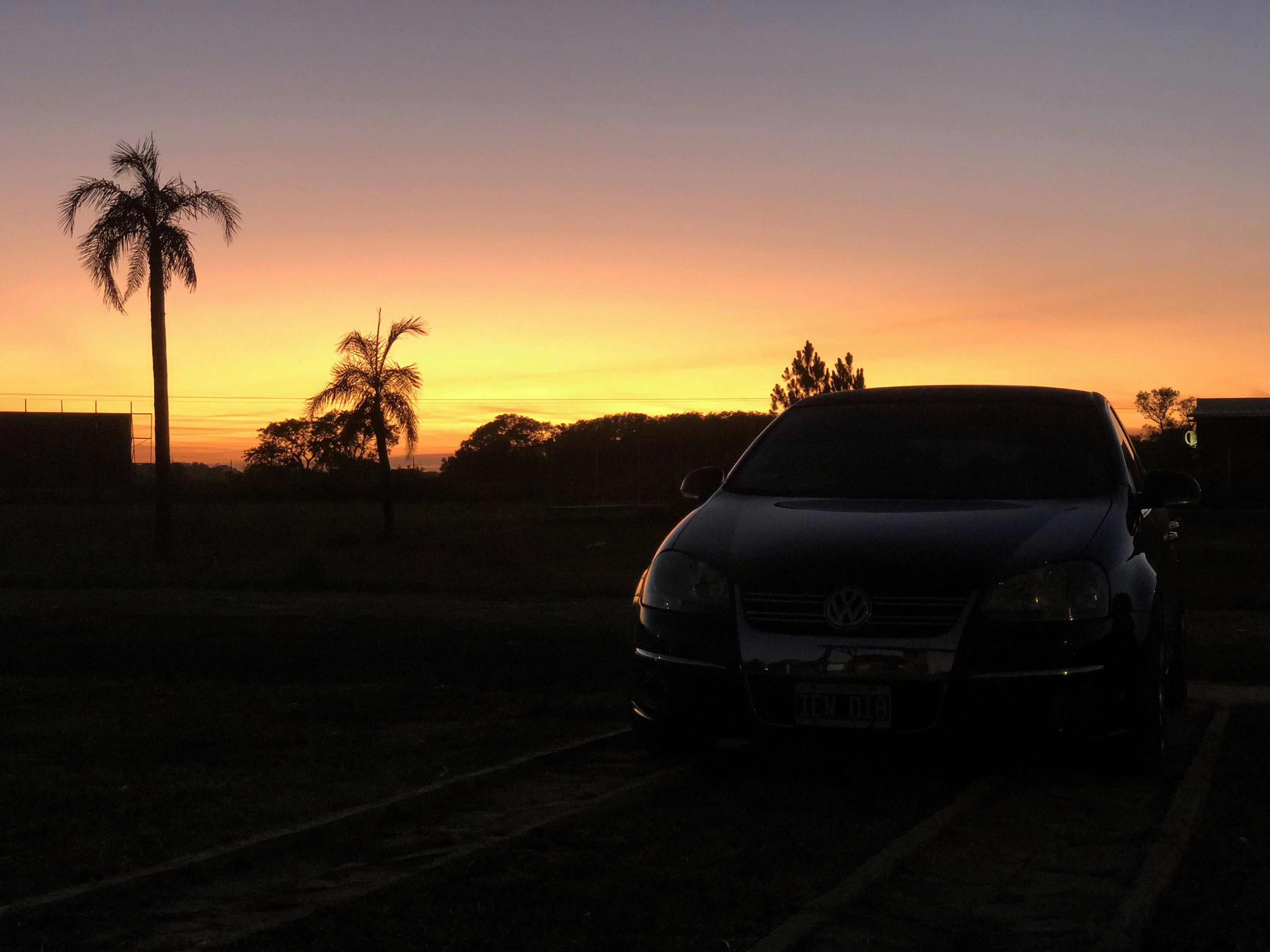 a car parked in a parking lot at sunset