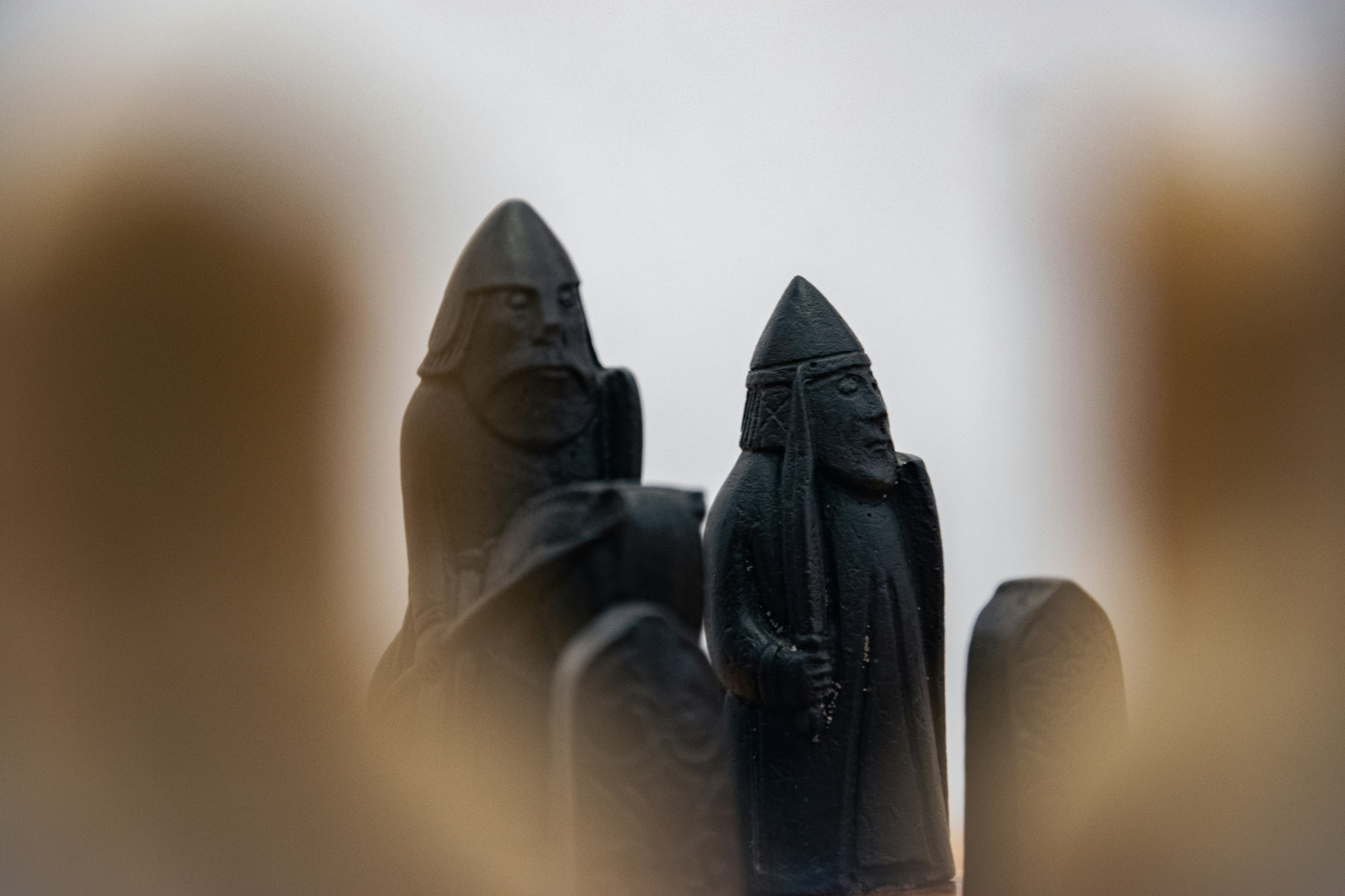 A group of black statues sitting next to each other photo – Free Woman ...