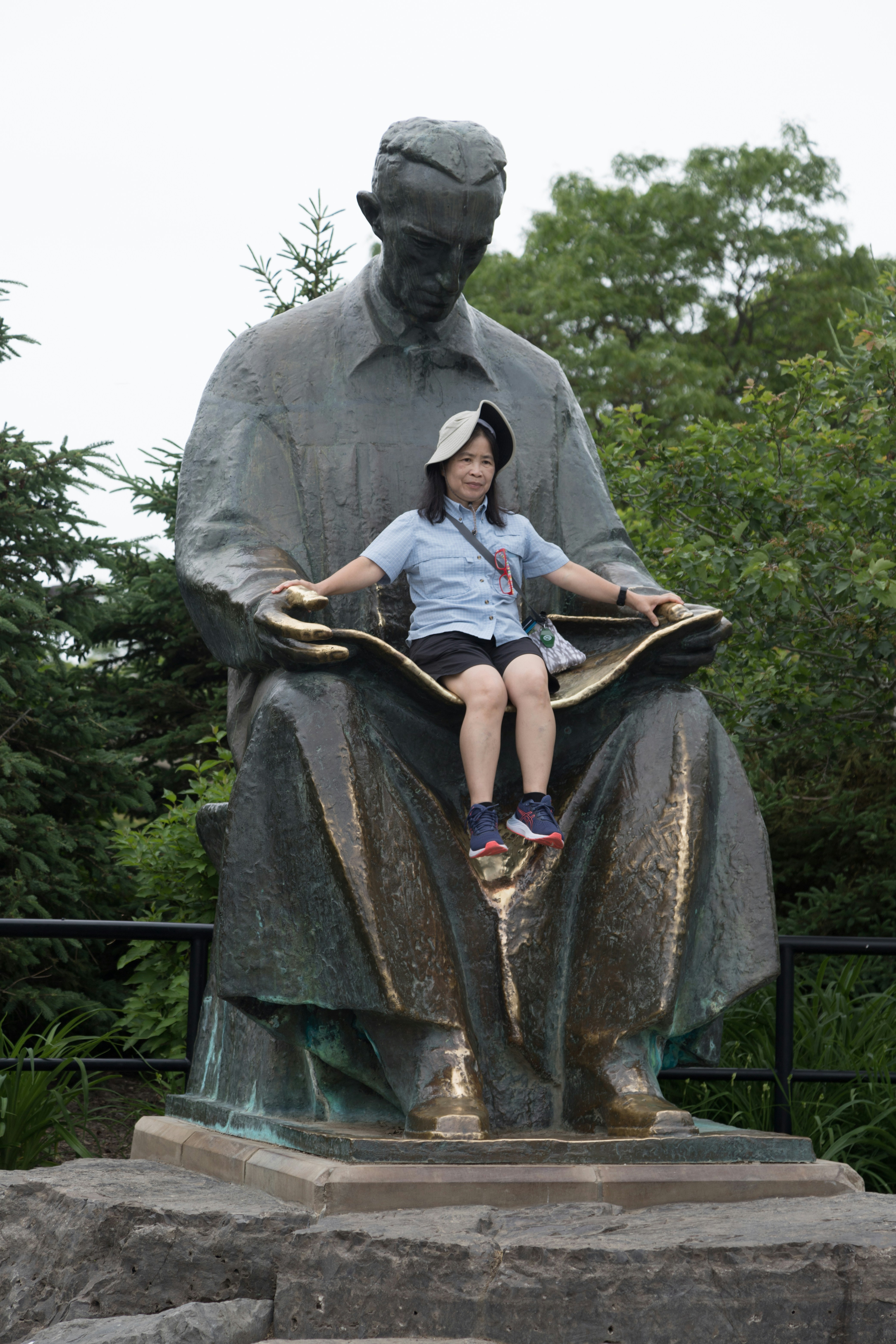 A young girl sitting on top of a statue of a man photo – Free Niagara ...