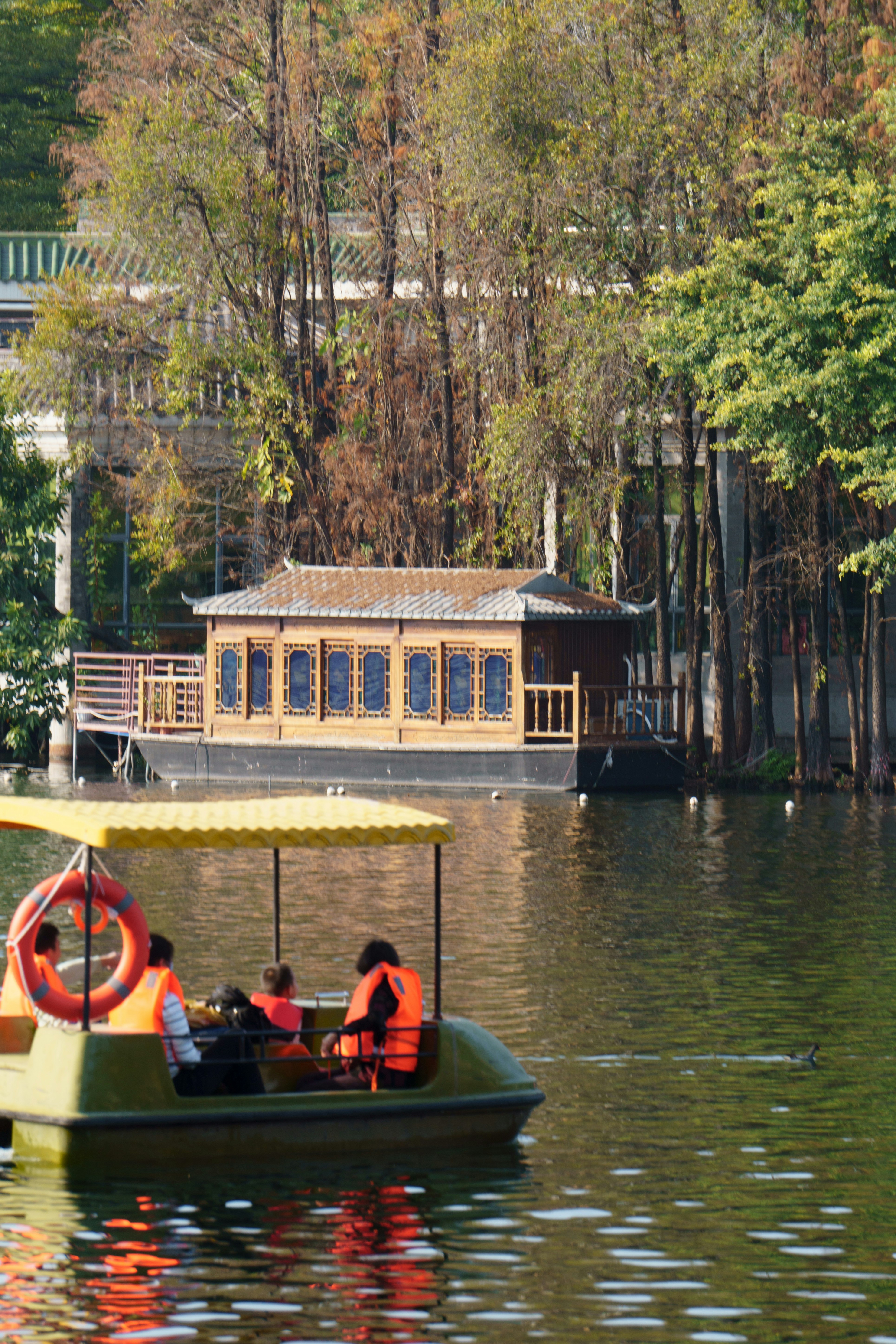 Orange Life Jackets on a Quiet Lake beside a Cedar Riverside House