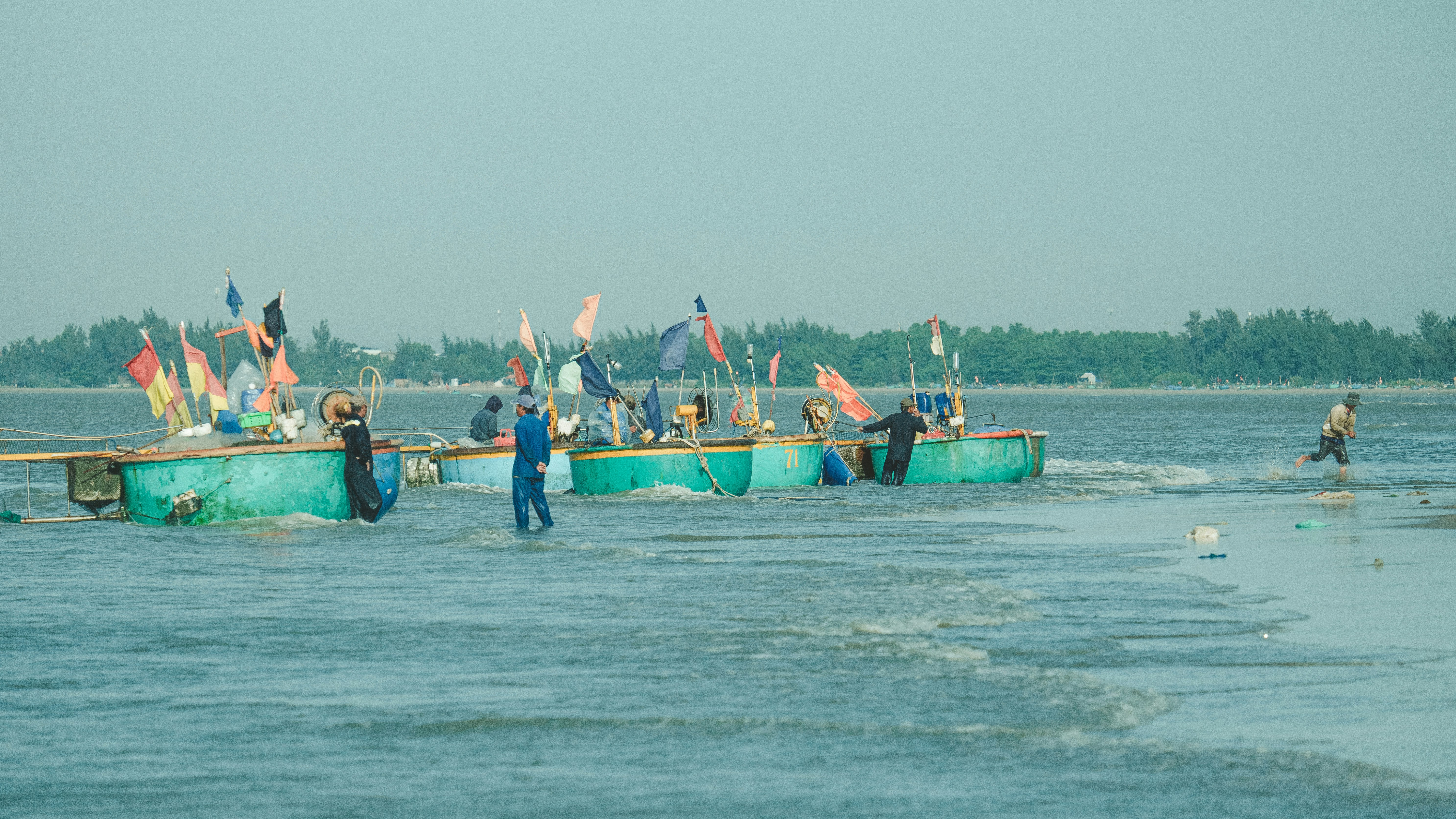 a group of people standing on top of a boat in the water