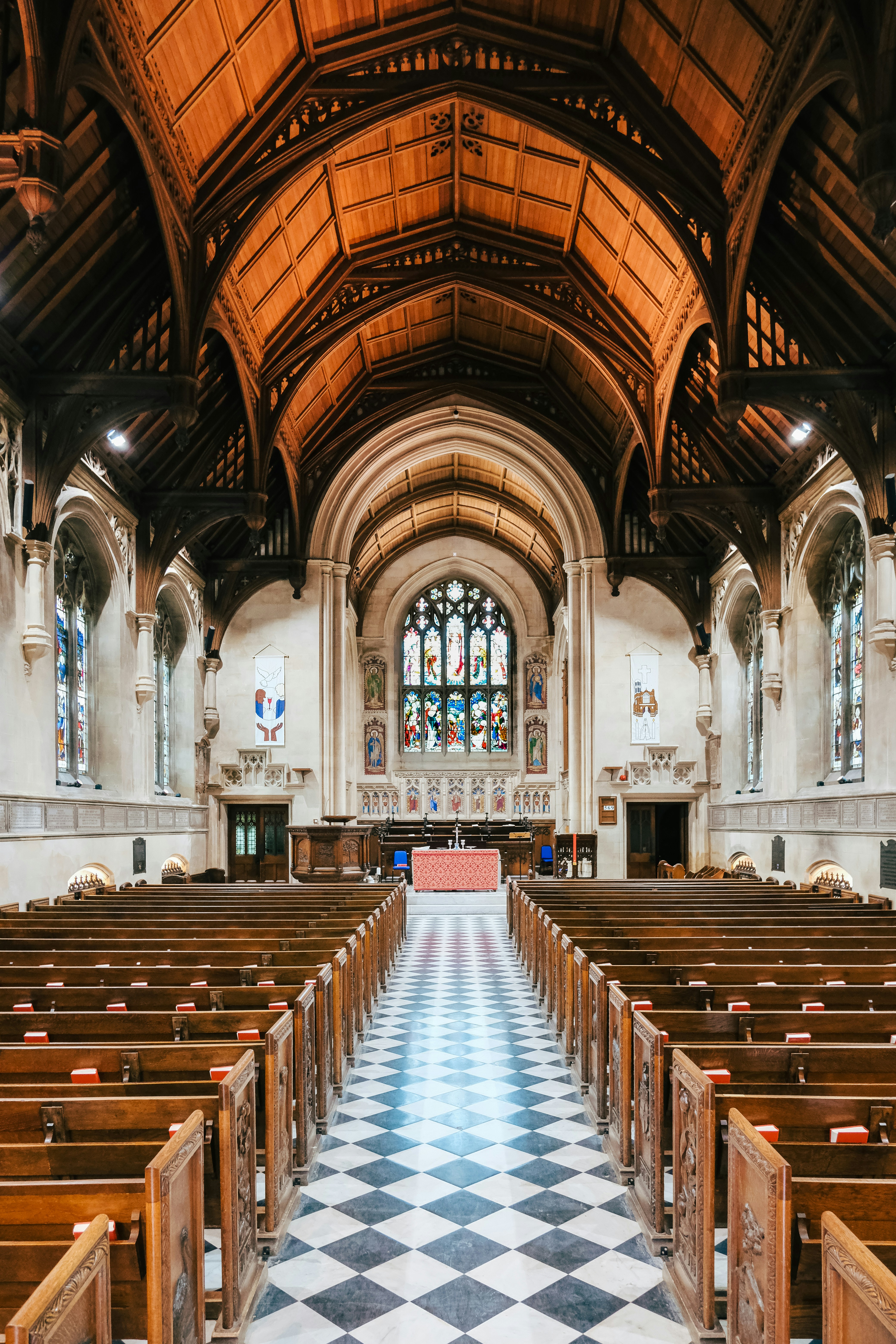 a large church with a checkered floor and vaulted ceiling