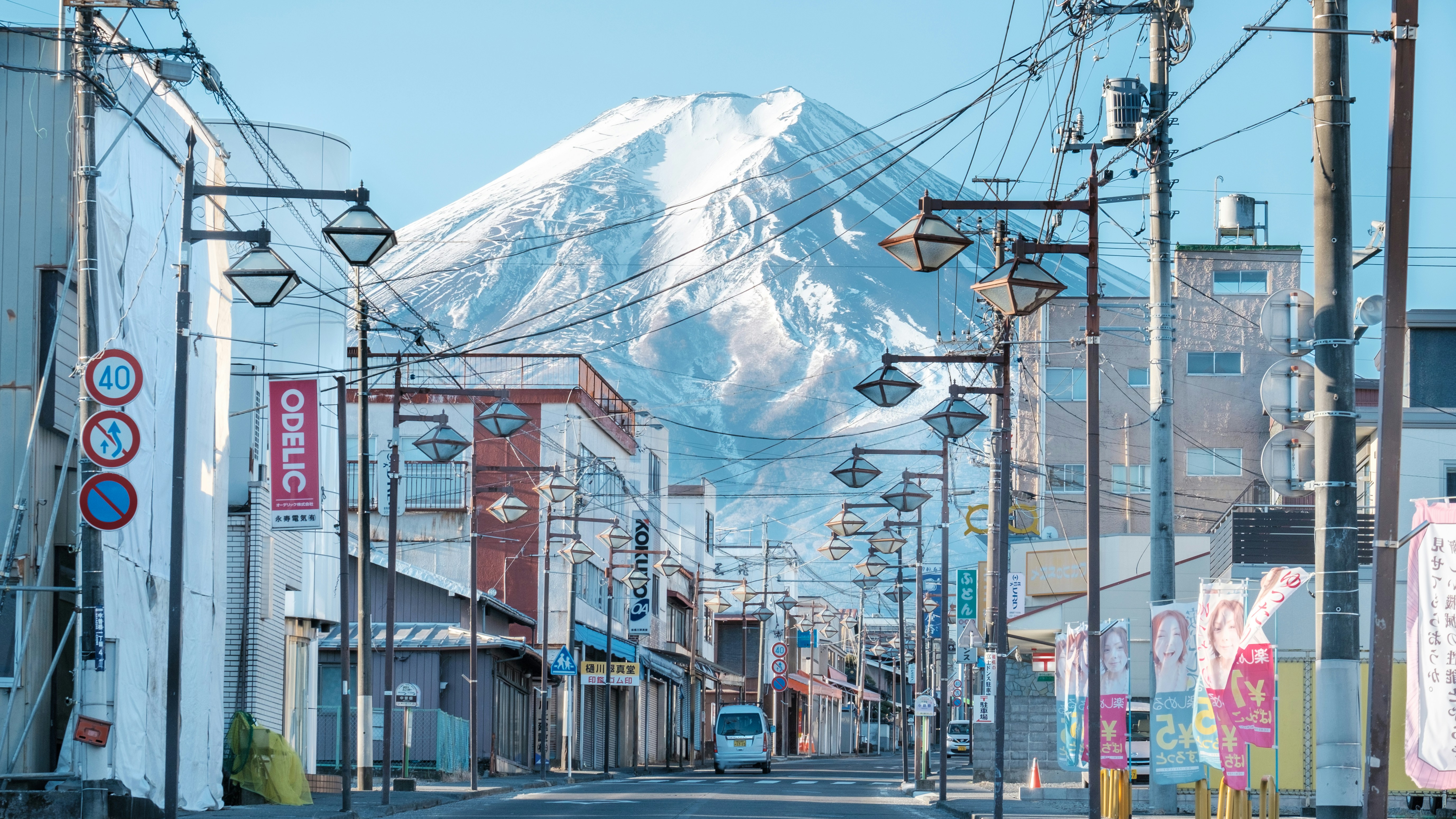 a city street with a mountain in the background