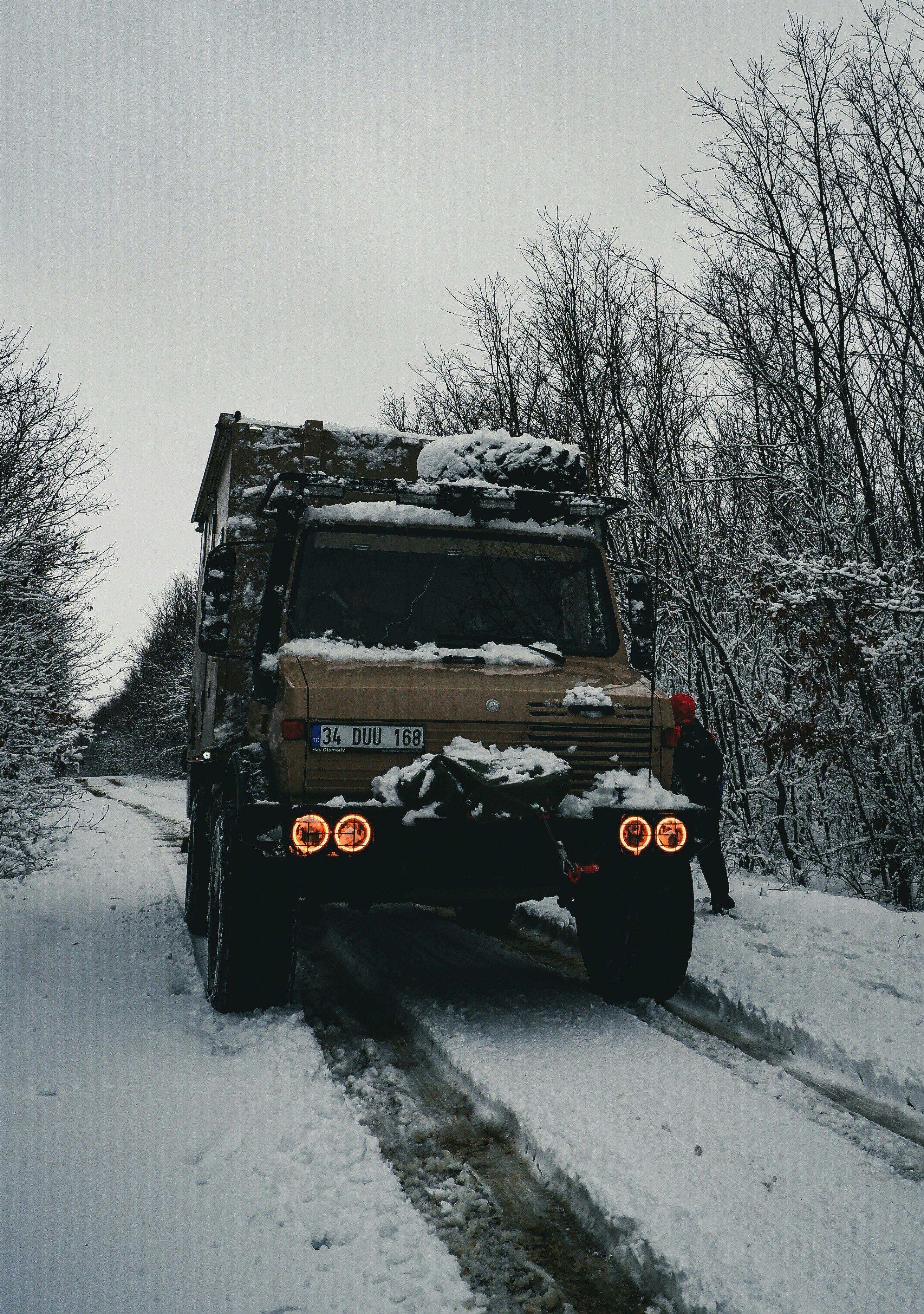 Snowbound Lorry Trek: A Winter Road Vigil with Headlights Luminous
