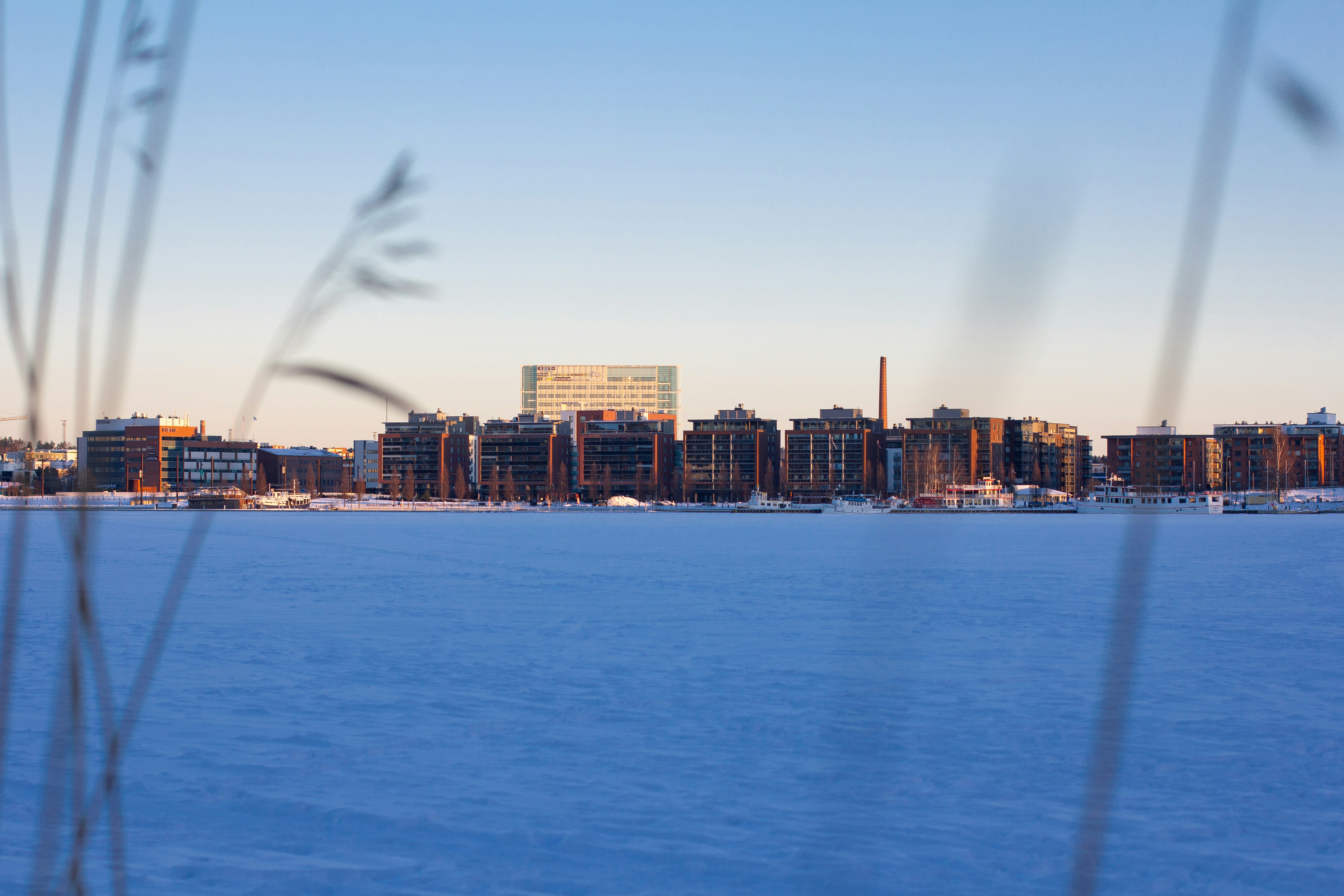 Glacial Horizons: City Skyline Across the Ice at Blue Hour