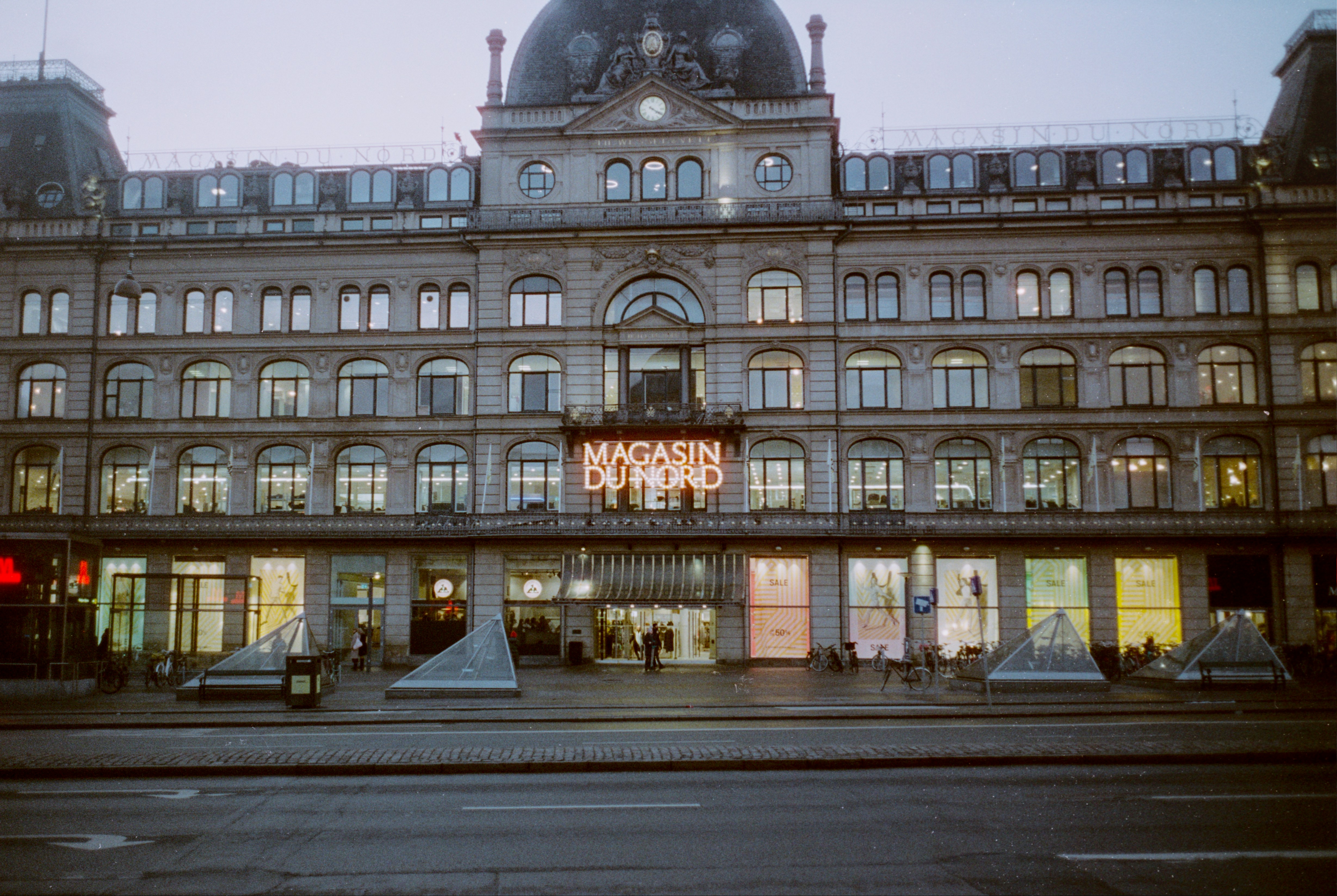 Magasin du Nord | a large building with a clock on the front of it