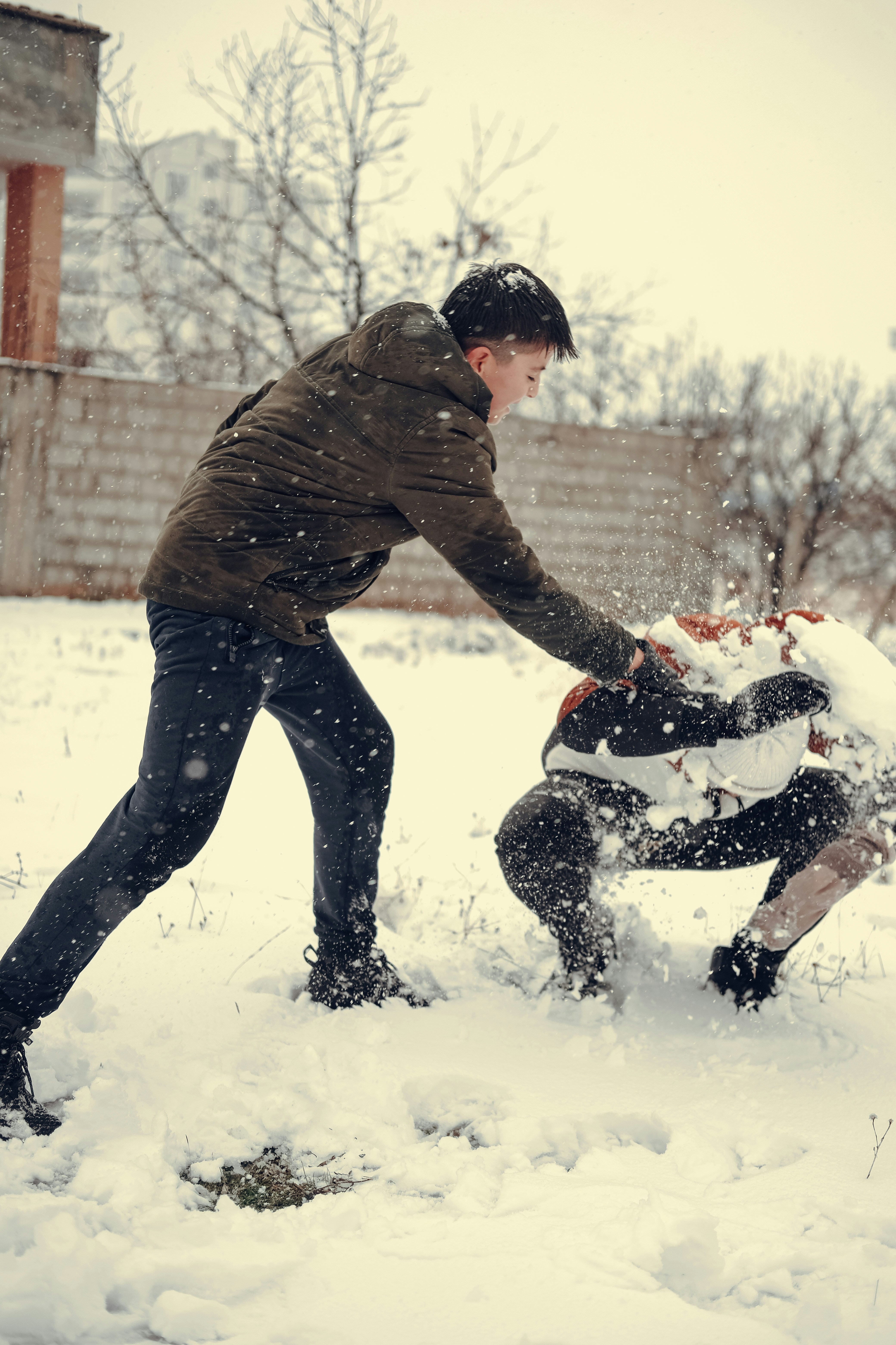 Snowy Tug of War: Winter Struggle Between Friends