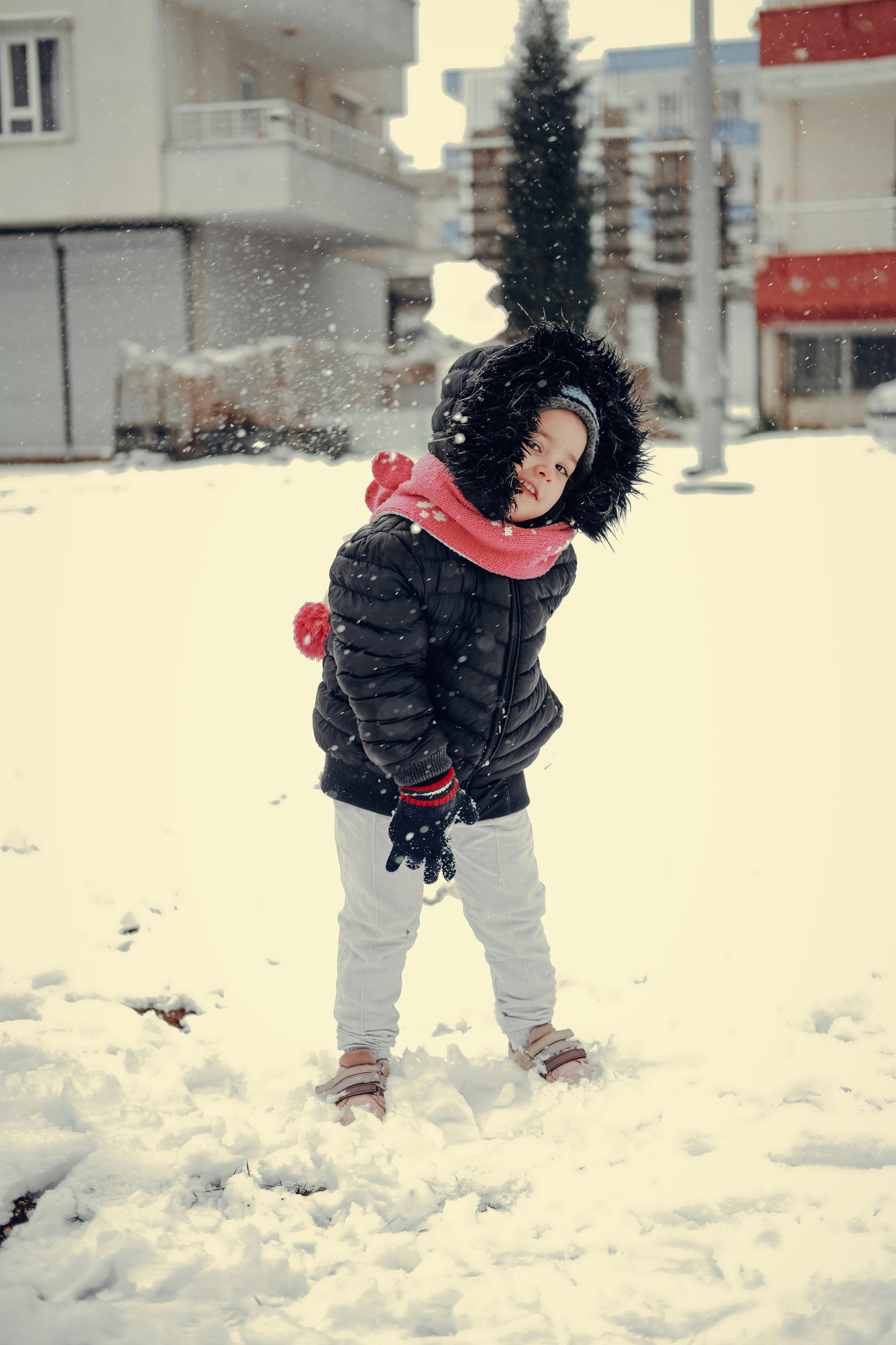 Snowbound Pause: A Curious Child in a Pink-Scarf Moment