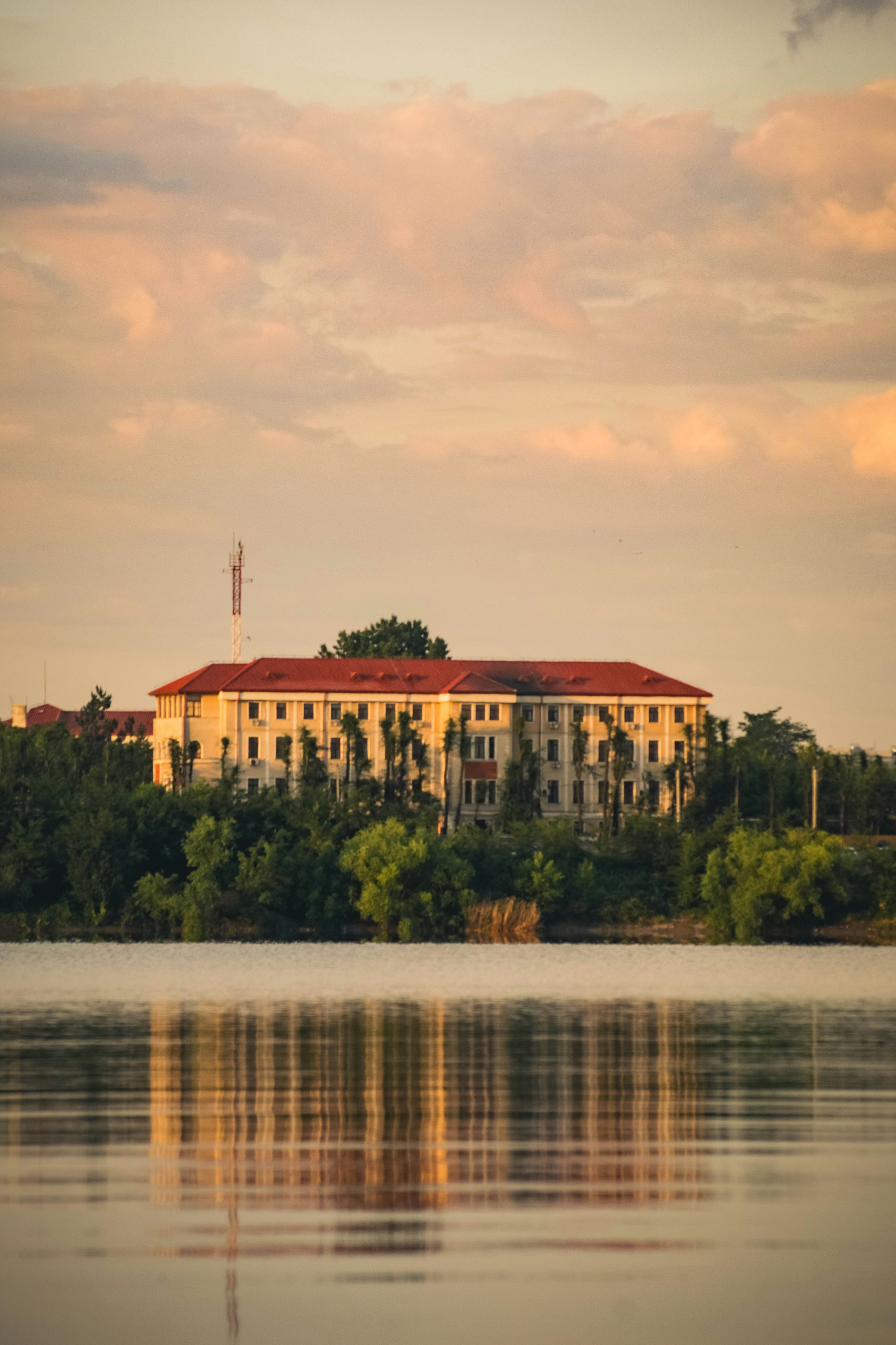a large building sitting on top of a lush green hillside