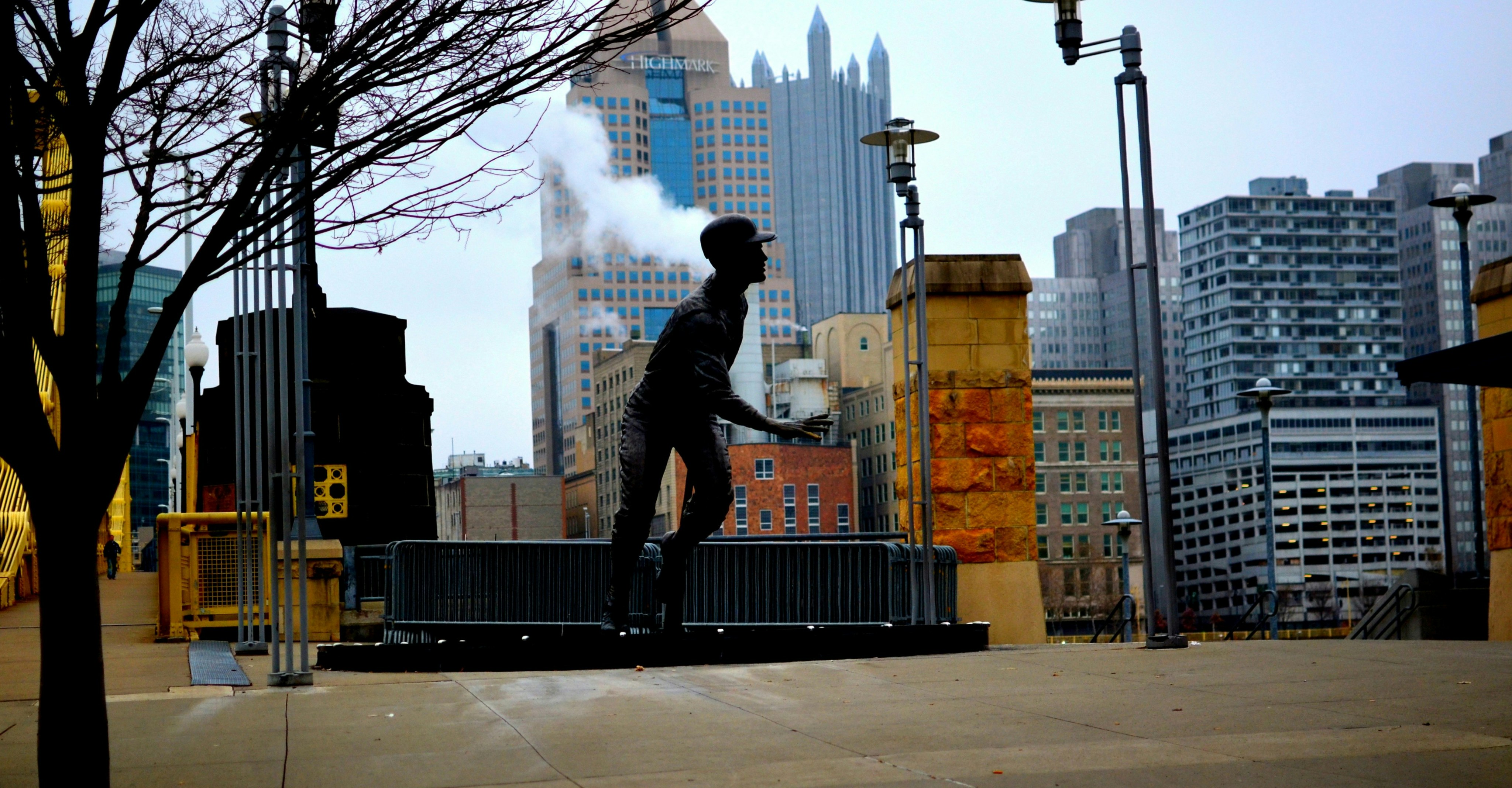 Silhouette of a Jumping Figure Against a Cityscape
