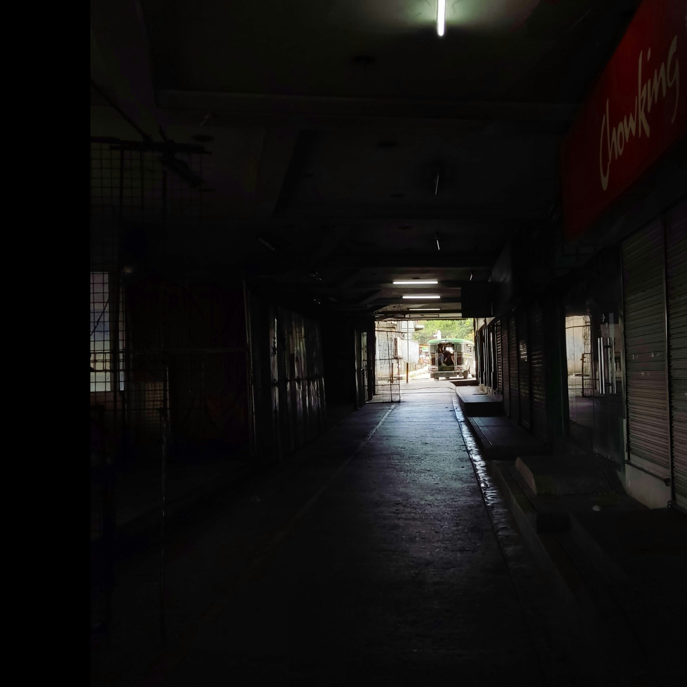 A dark hallway with a light hanging from the ceiling photo – Free ...