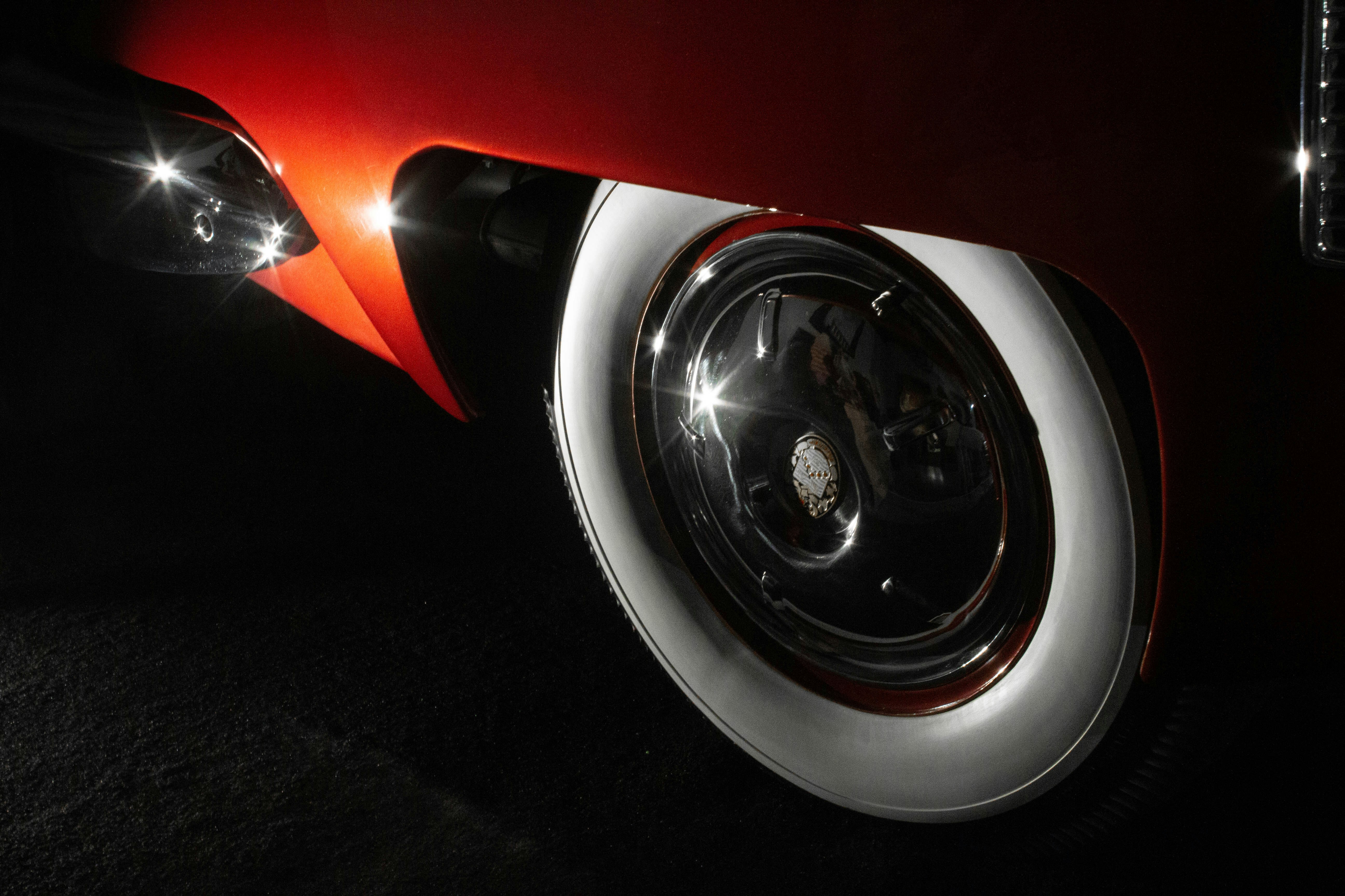 Gleaming Whitewall: Night Portrait of a Vintage Car Wheel