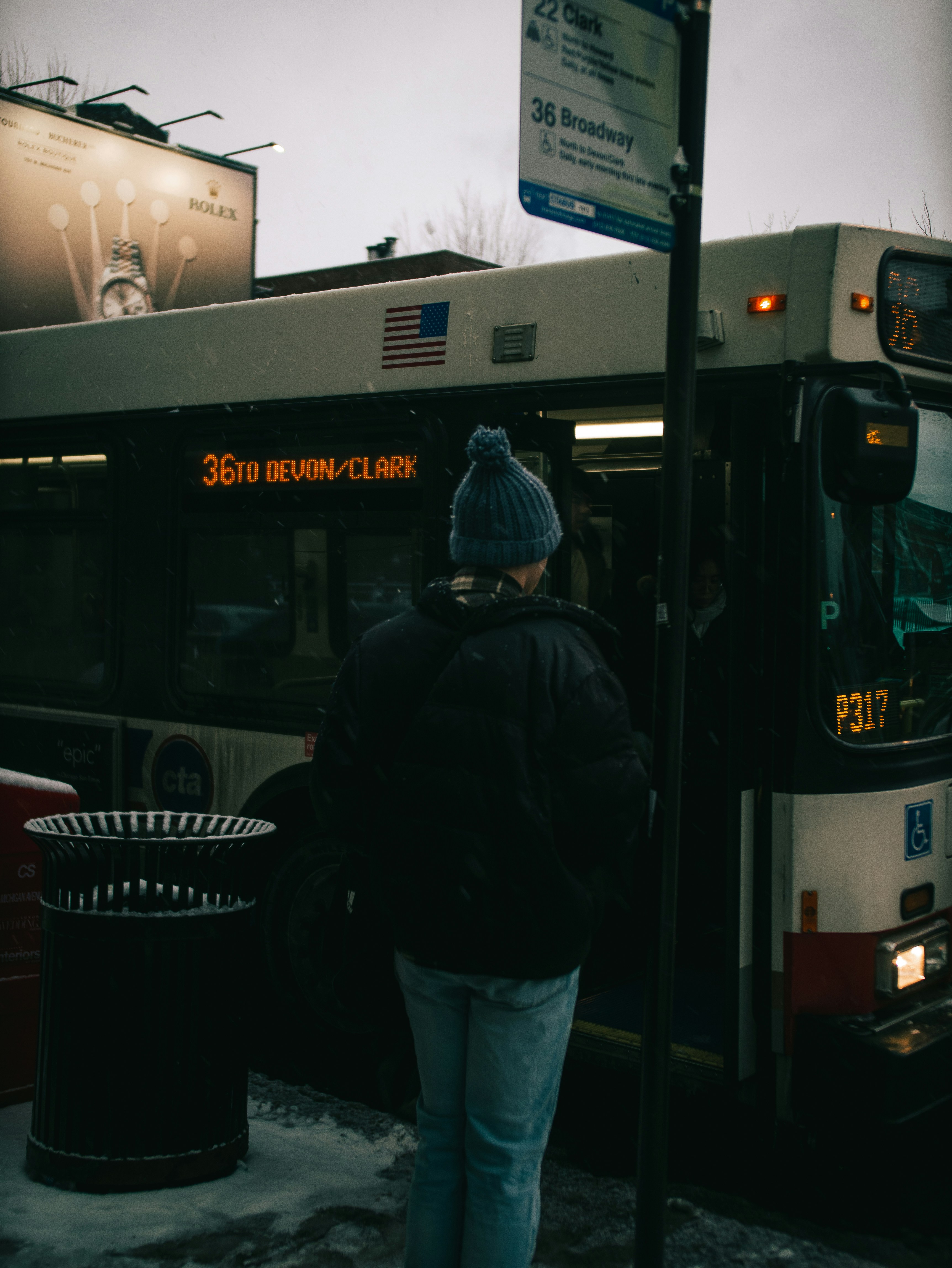 Blue Beanie at the Bus Stop: Winter Pause in a City Transit Scene