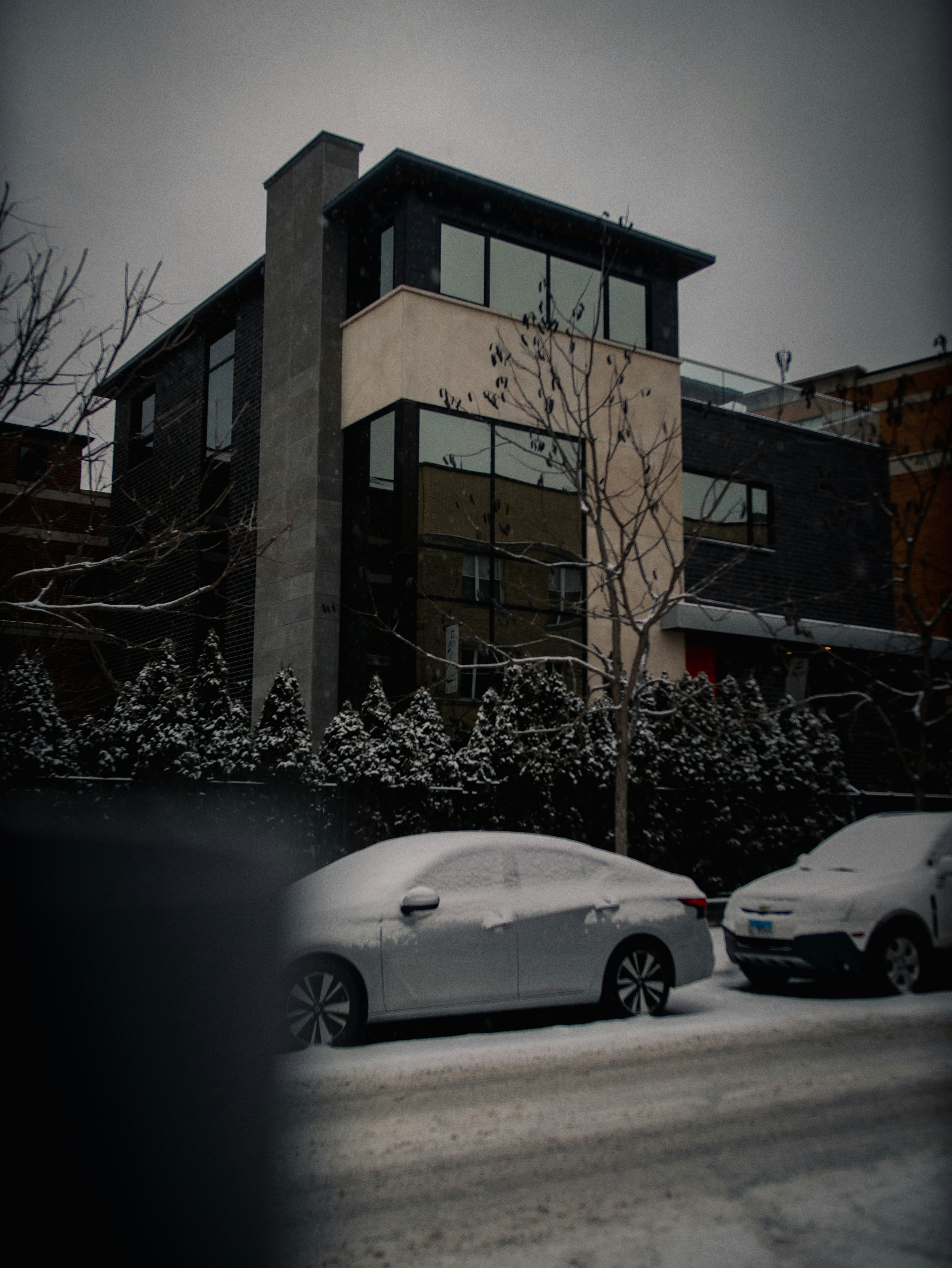 a couple of cars parked in front of a building